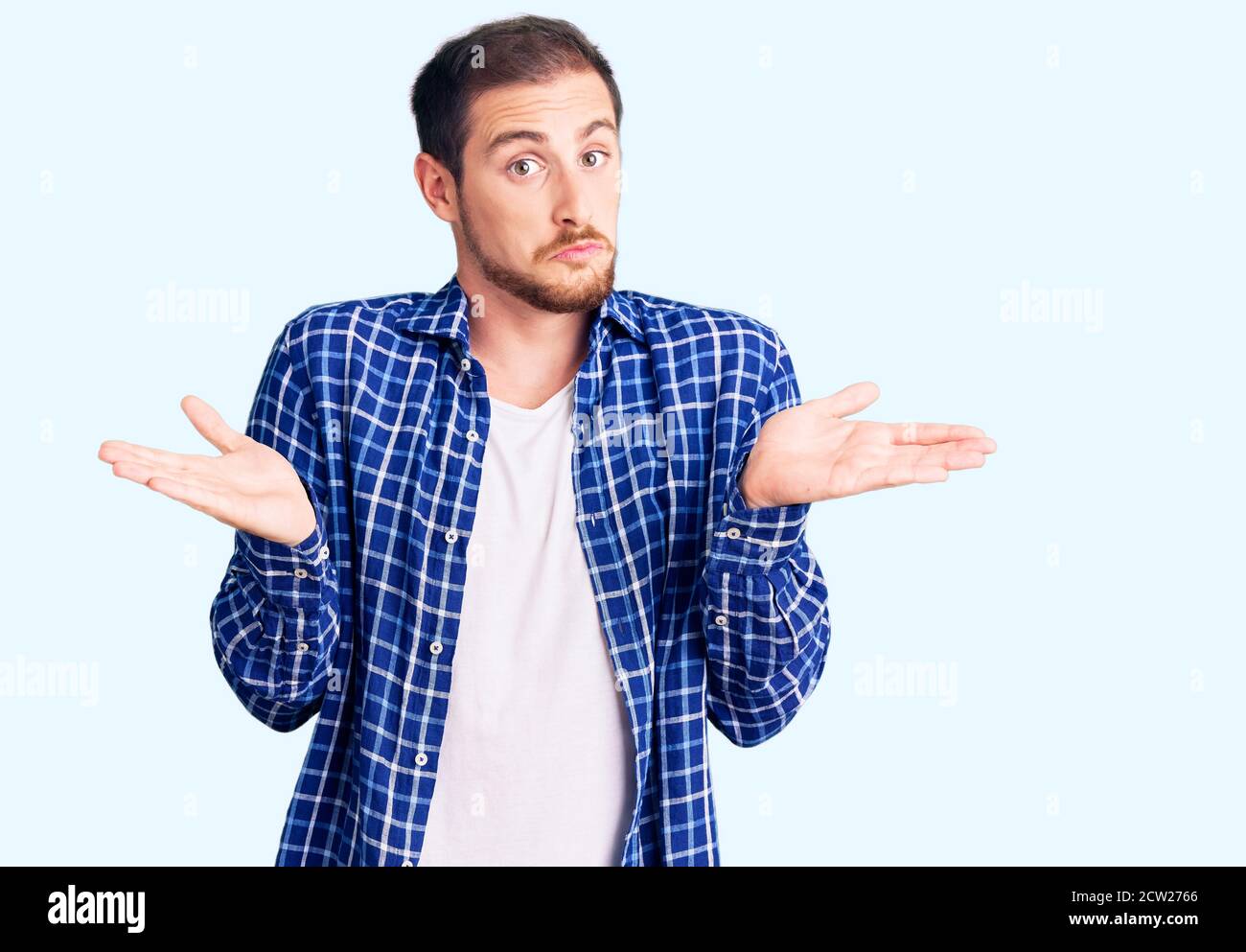 Young handsome caucasian man wearing casual clothes clueless and ...