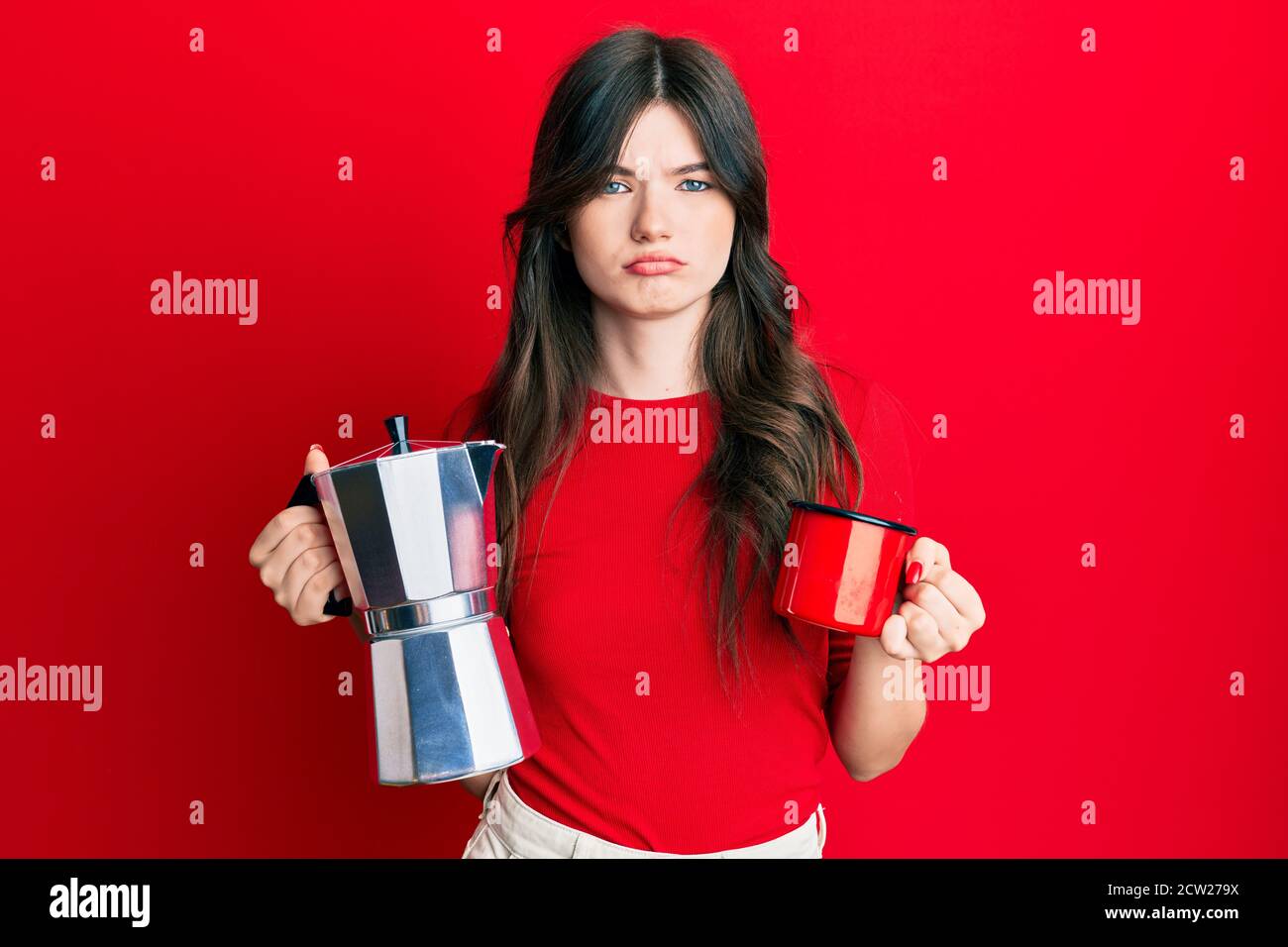 Young beautiful caucasian girl drinking italian coffee depressed and ...