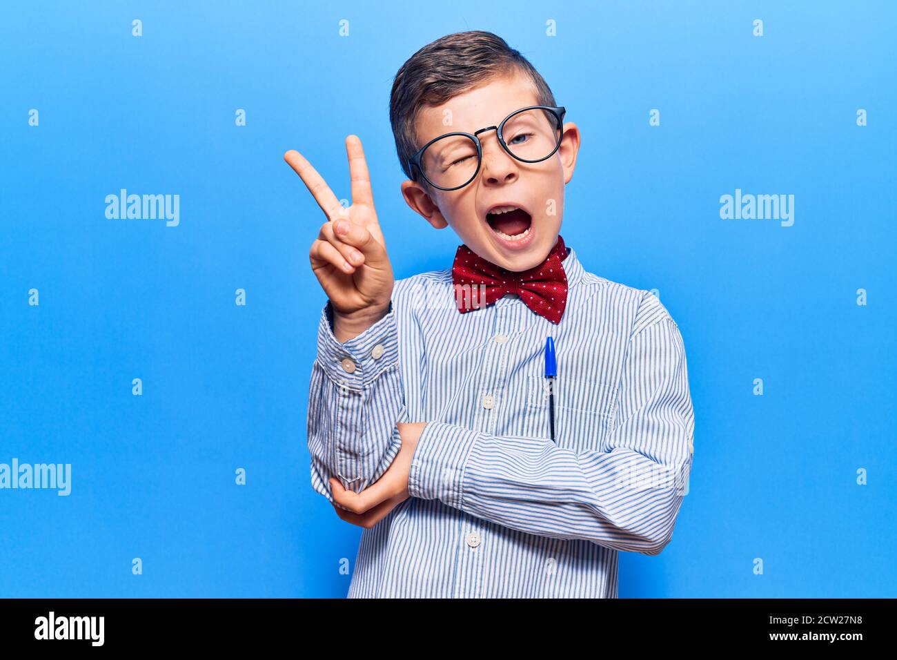 Cute blond kid wearing nerd bow tie and glasses smiling with happy face ...