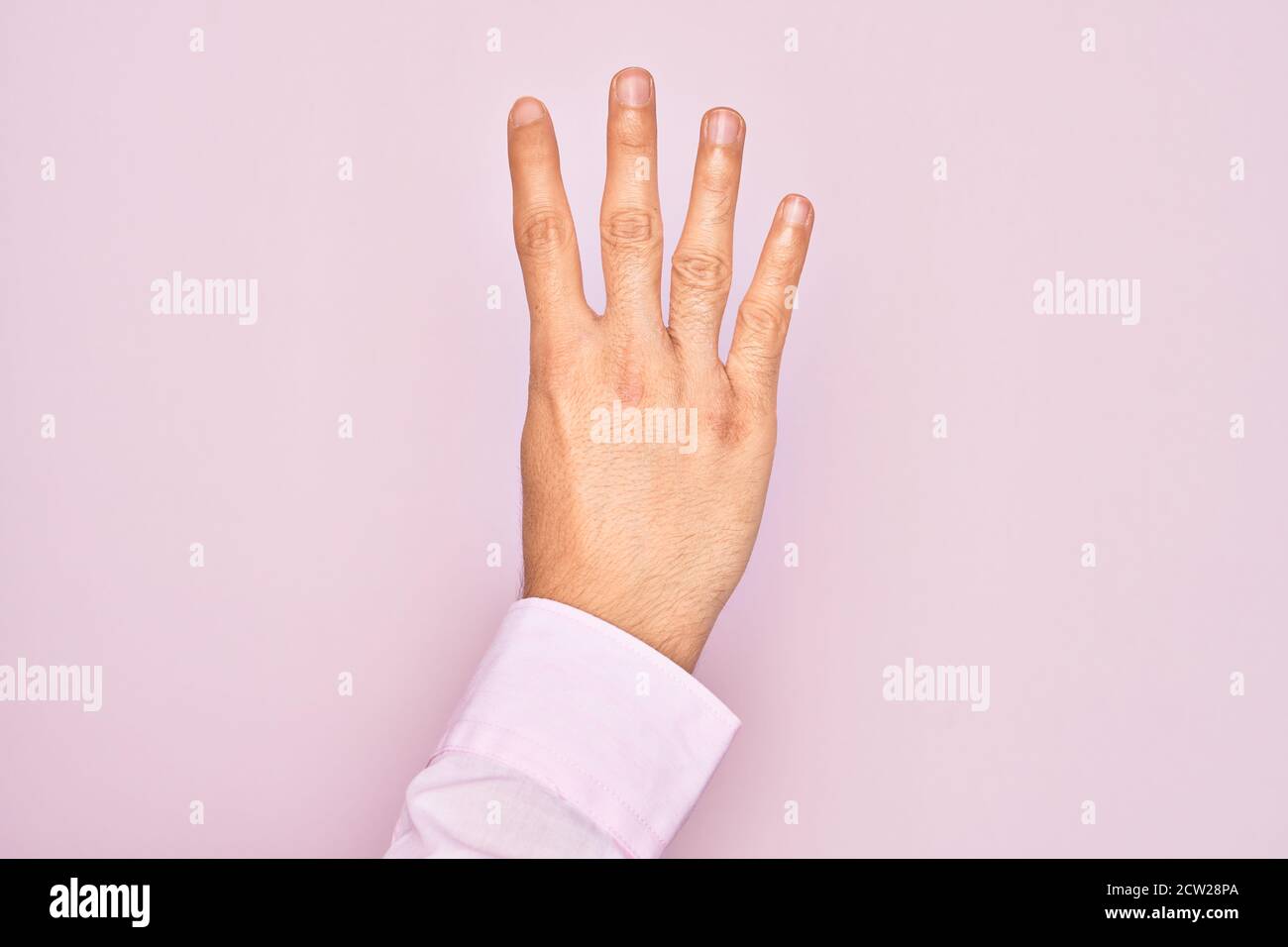 Hand of caucasian young man showing fingers over isolated pink ...