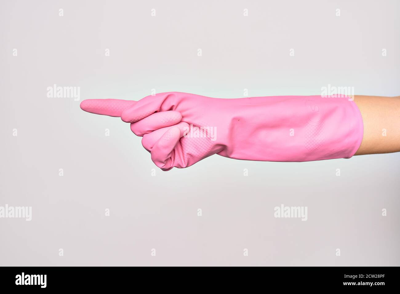 Hand of caucasian young woman wearing pink cleaning glove. Pointing ...