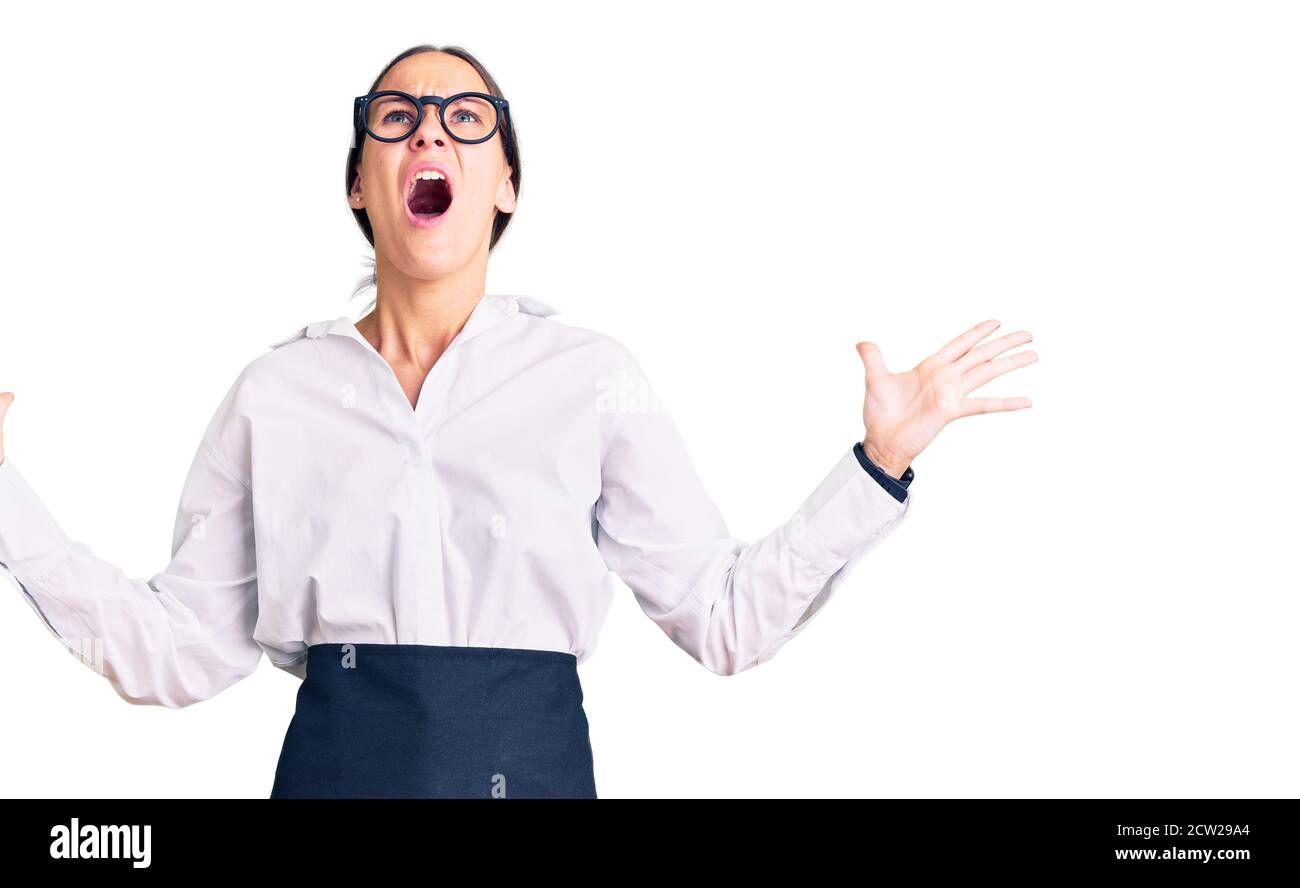 Beautiful brunette young woman wearing professional waitress apron ...