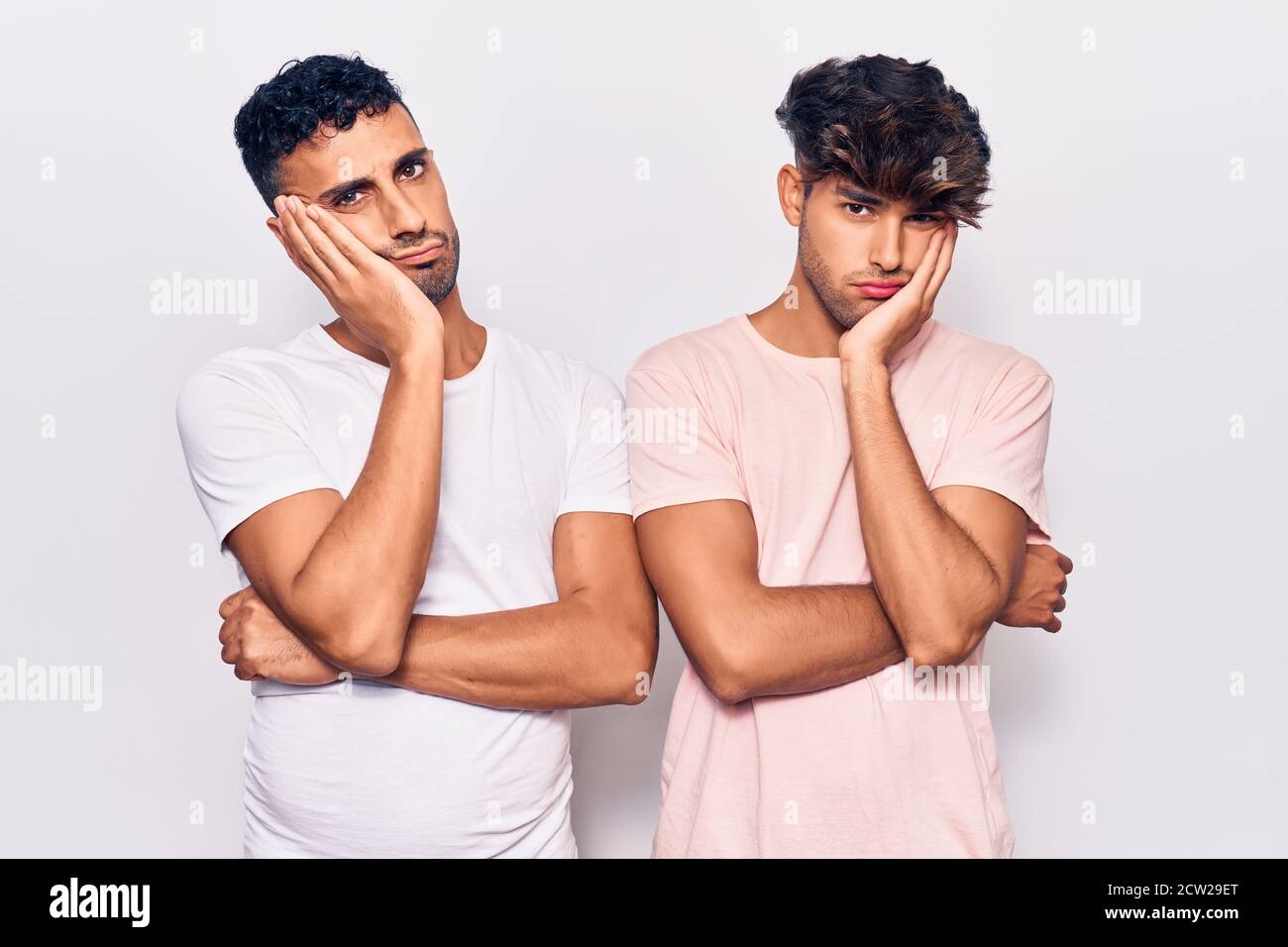 Young gay couple wearing casual clothes thinking looking tired and ...