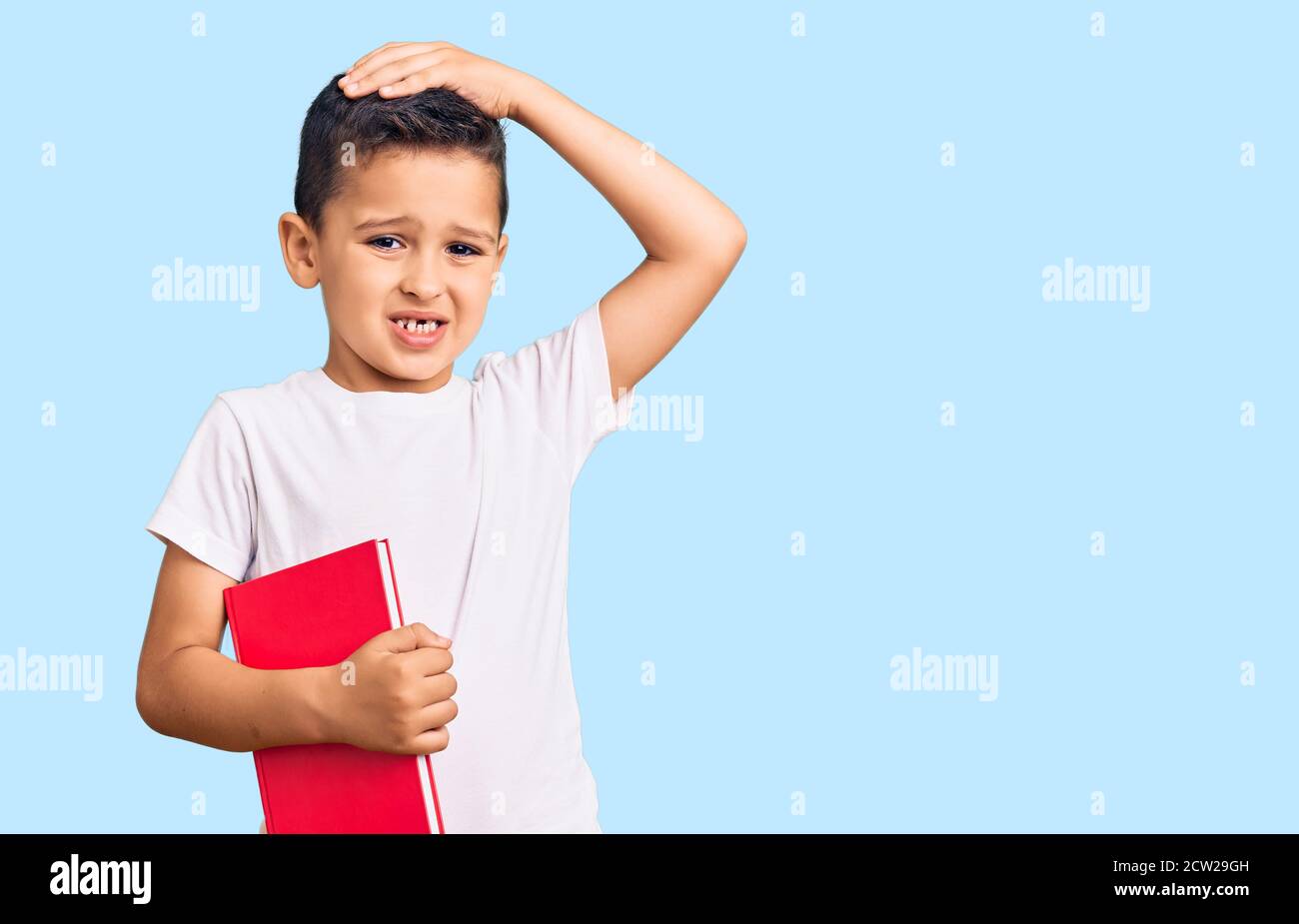 Little cute boy kid reading a book stressed and frustrated with hand on ...