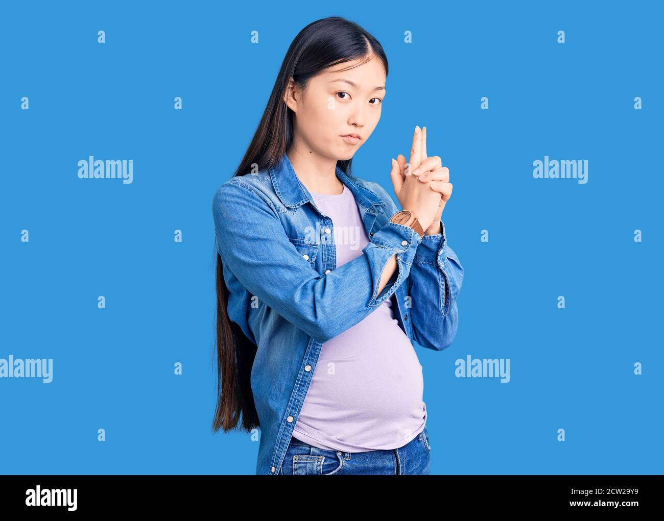 Young beautiful chinese woman pregnant expecting baby holding symbolic ...