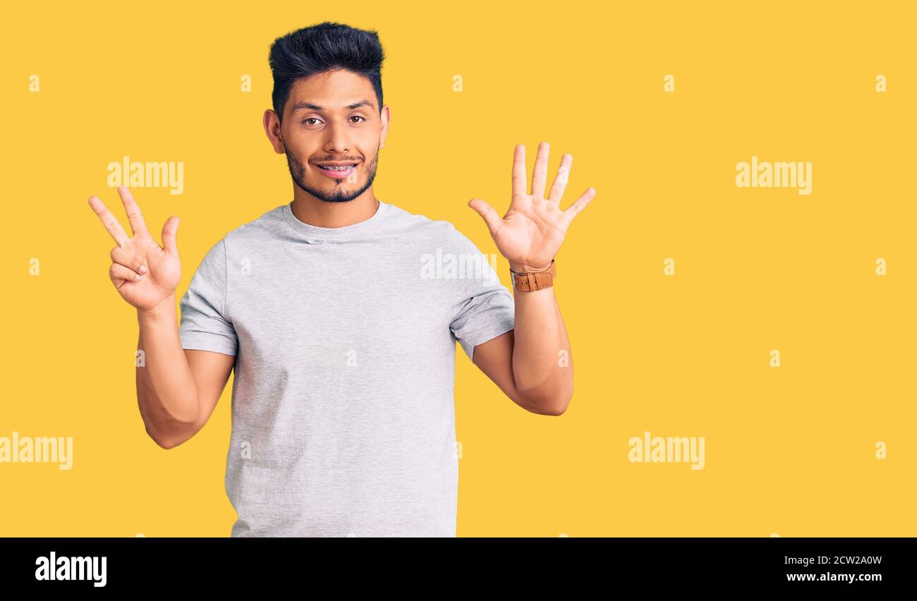 Handsome latin american young man wearing casual tshirt showing and ...