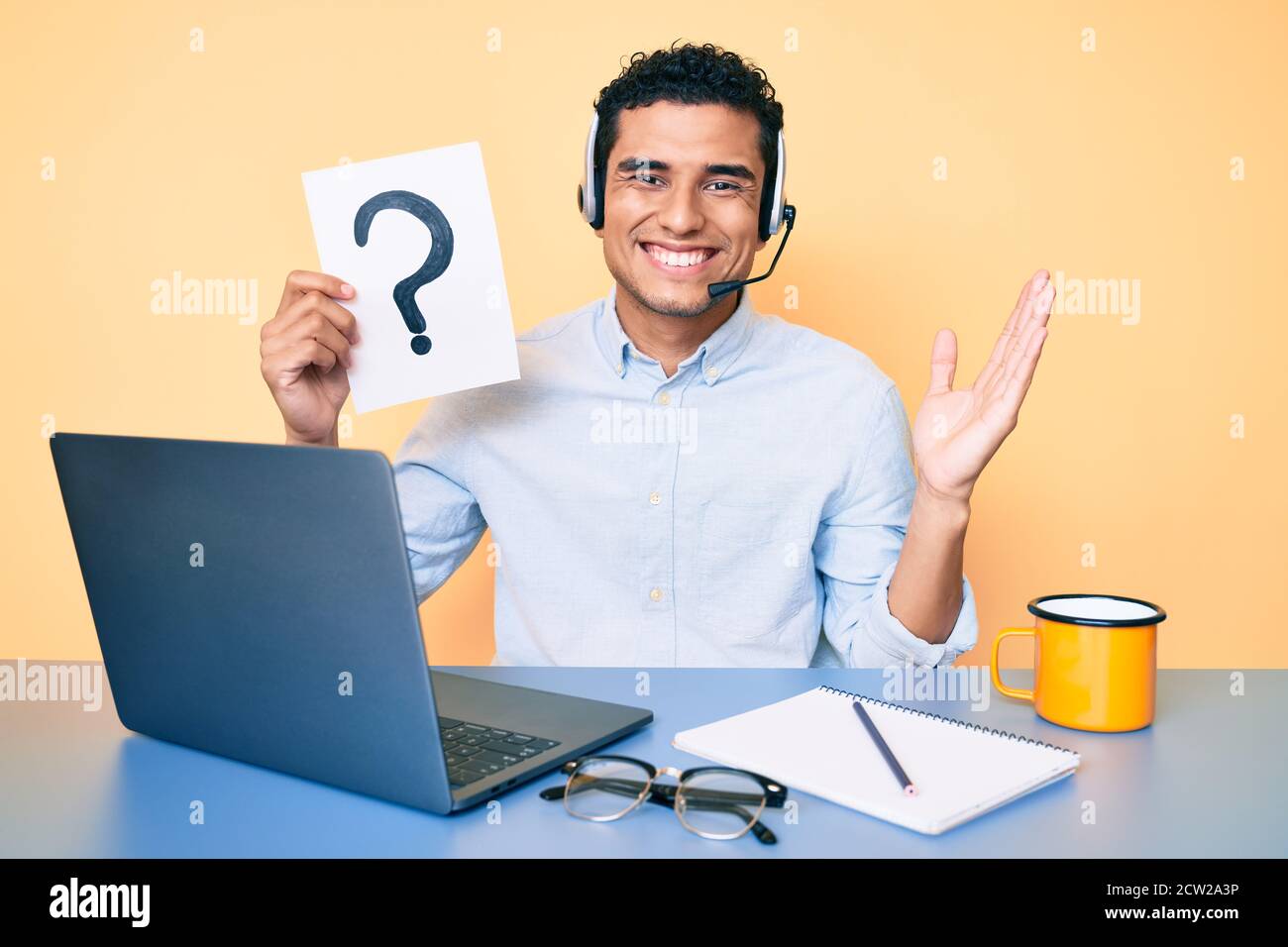 Young handsome hispanic man holding question mark as customer support ...