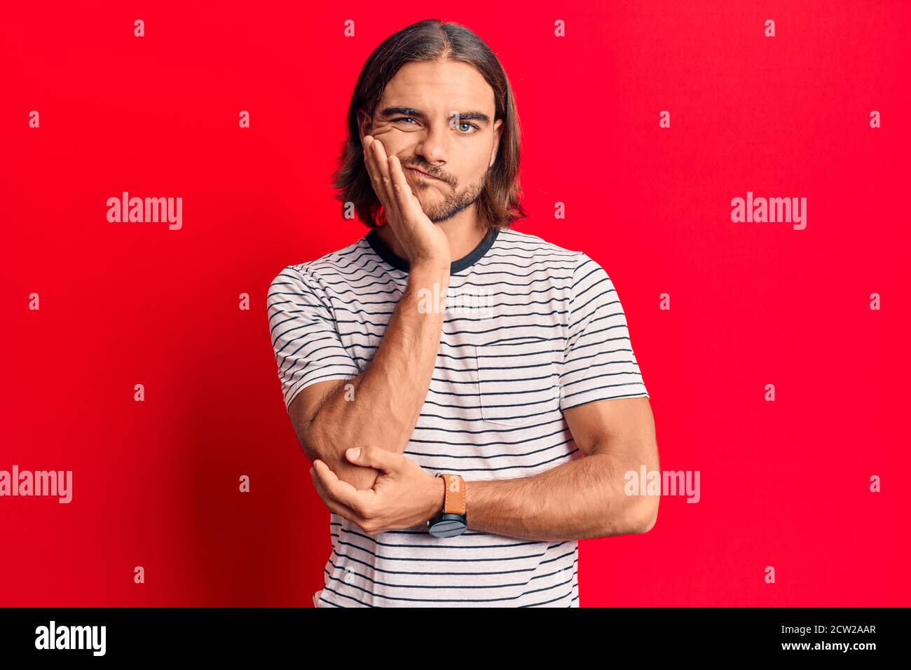 Young handsome man wearing casual clothes thinking looking tired and ...