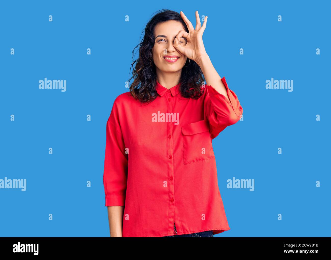 Young beautiful hispanic woman wearing casual clothes doing ok gesture ...