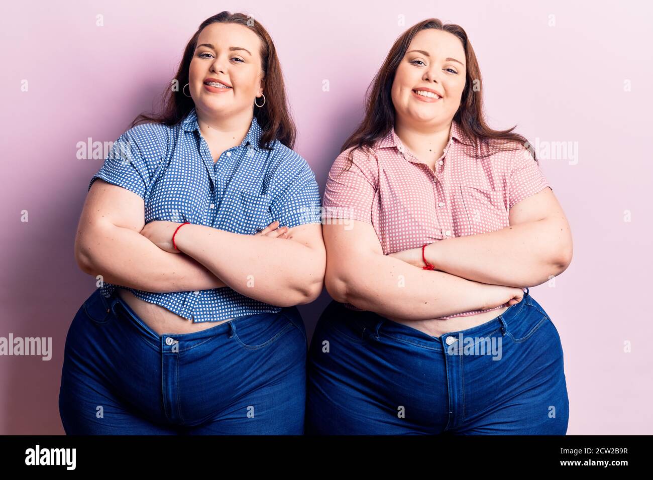 Young plus size twins wearing casual clothes happy face smiling with ...
