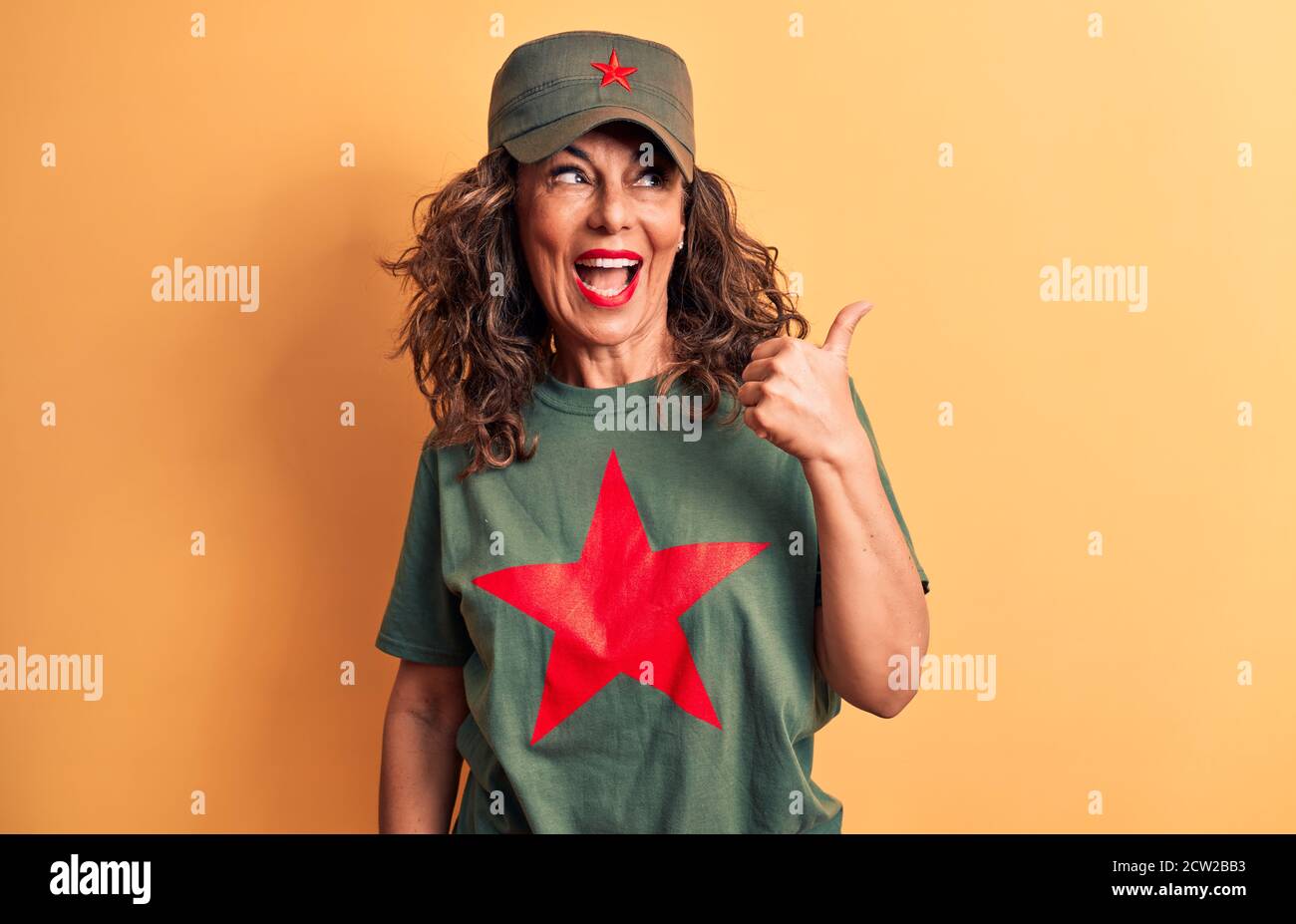 Middle age brunette woman wearing t-shirt and cap with red star symbol ...