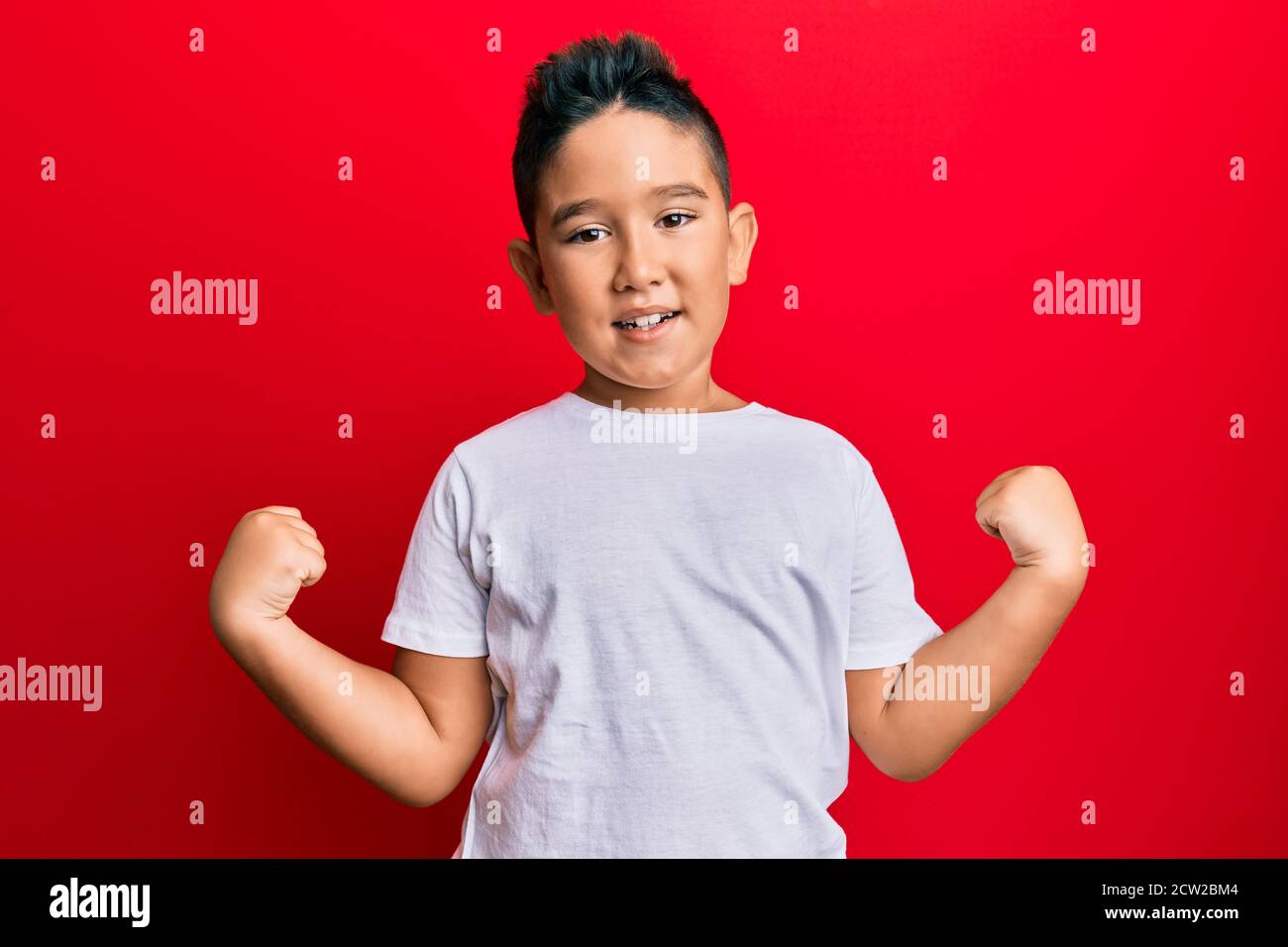 Little boy hispanic kid wearing casual white tshirt screaming proud ...