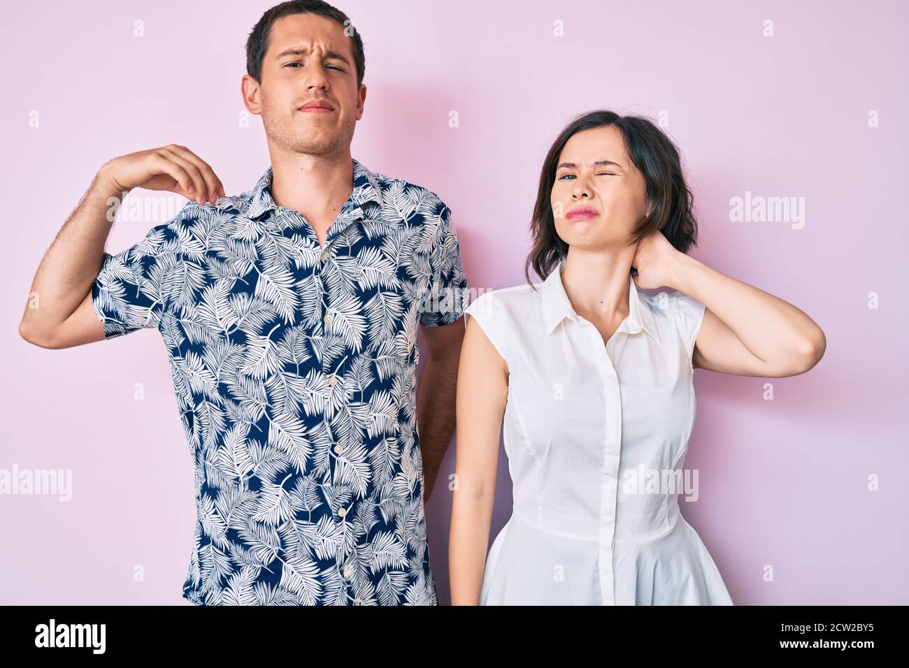 Beautiful couple wearing casual clothes suffering of neck ache injury ...
