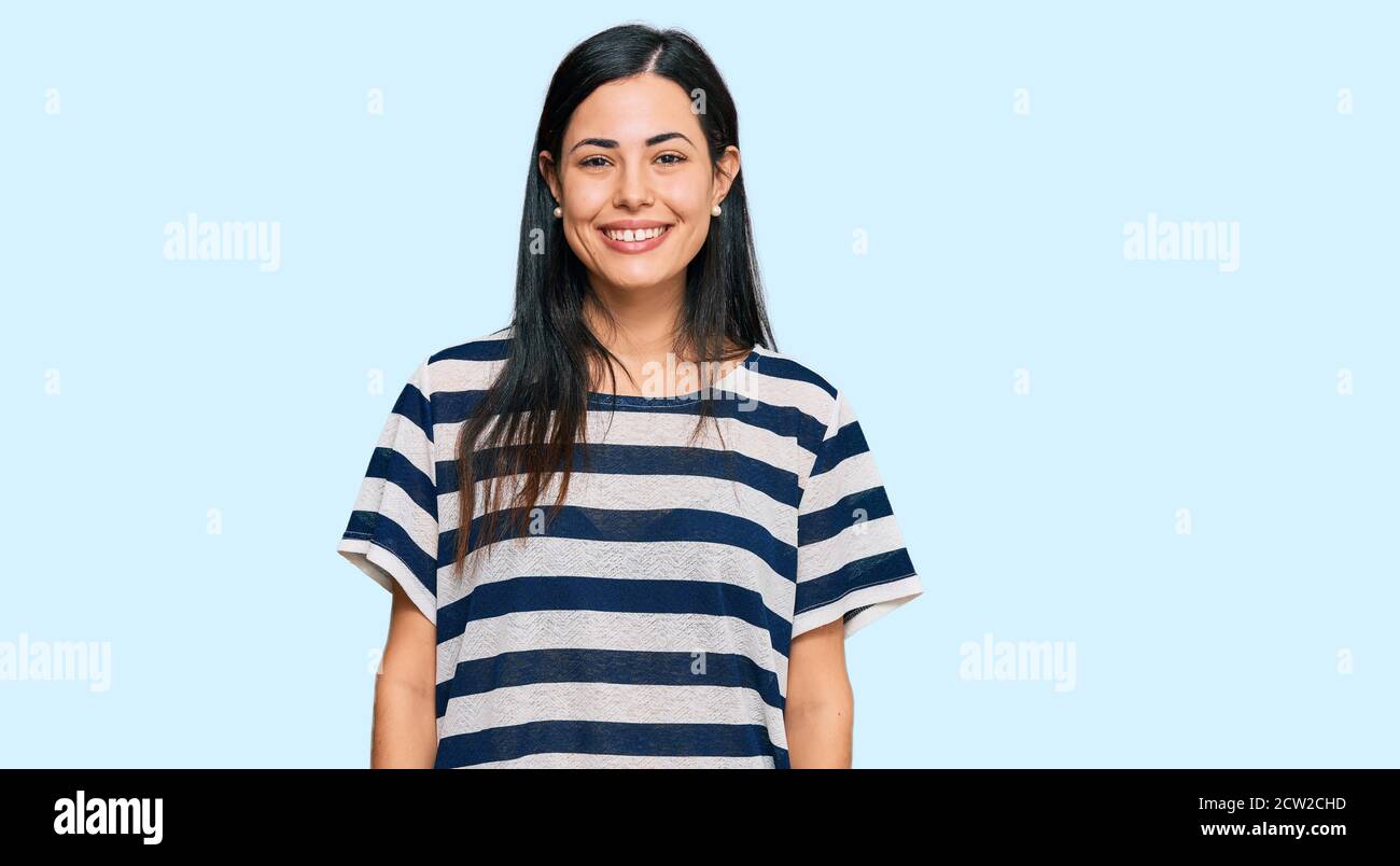 Beautiful young woman wearing casual clothes with a happy and cool ...