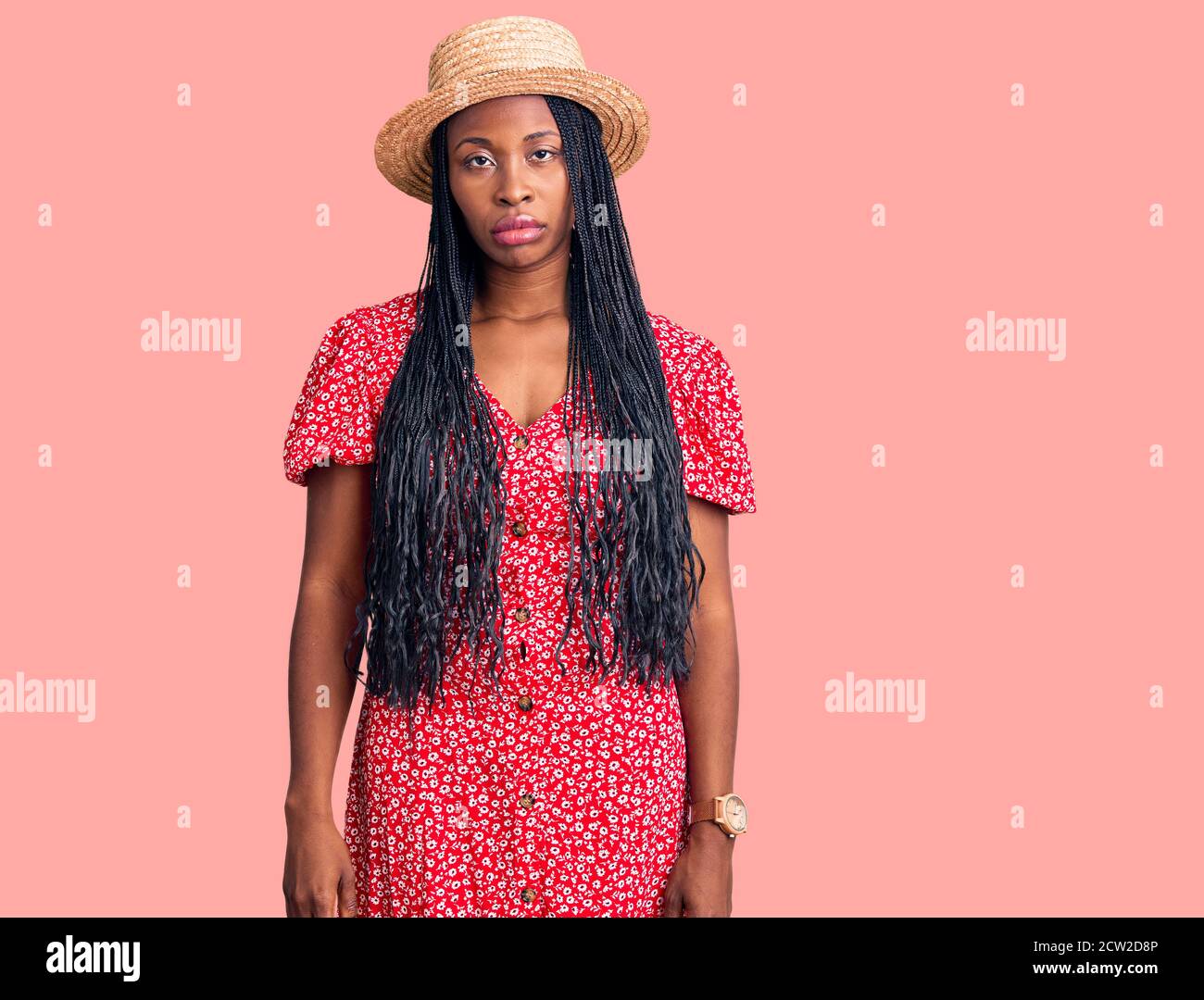 Young african american woman wearing summer hat skeptic and nervous ...
