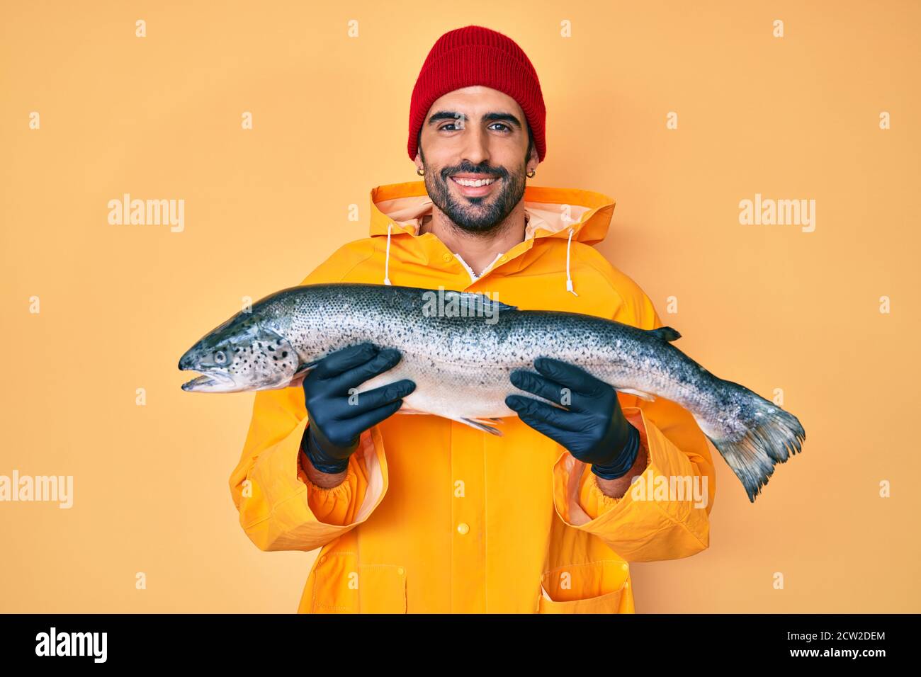 Handsome hispanic man with beard wearing fisherman equipment smiling ...