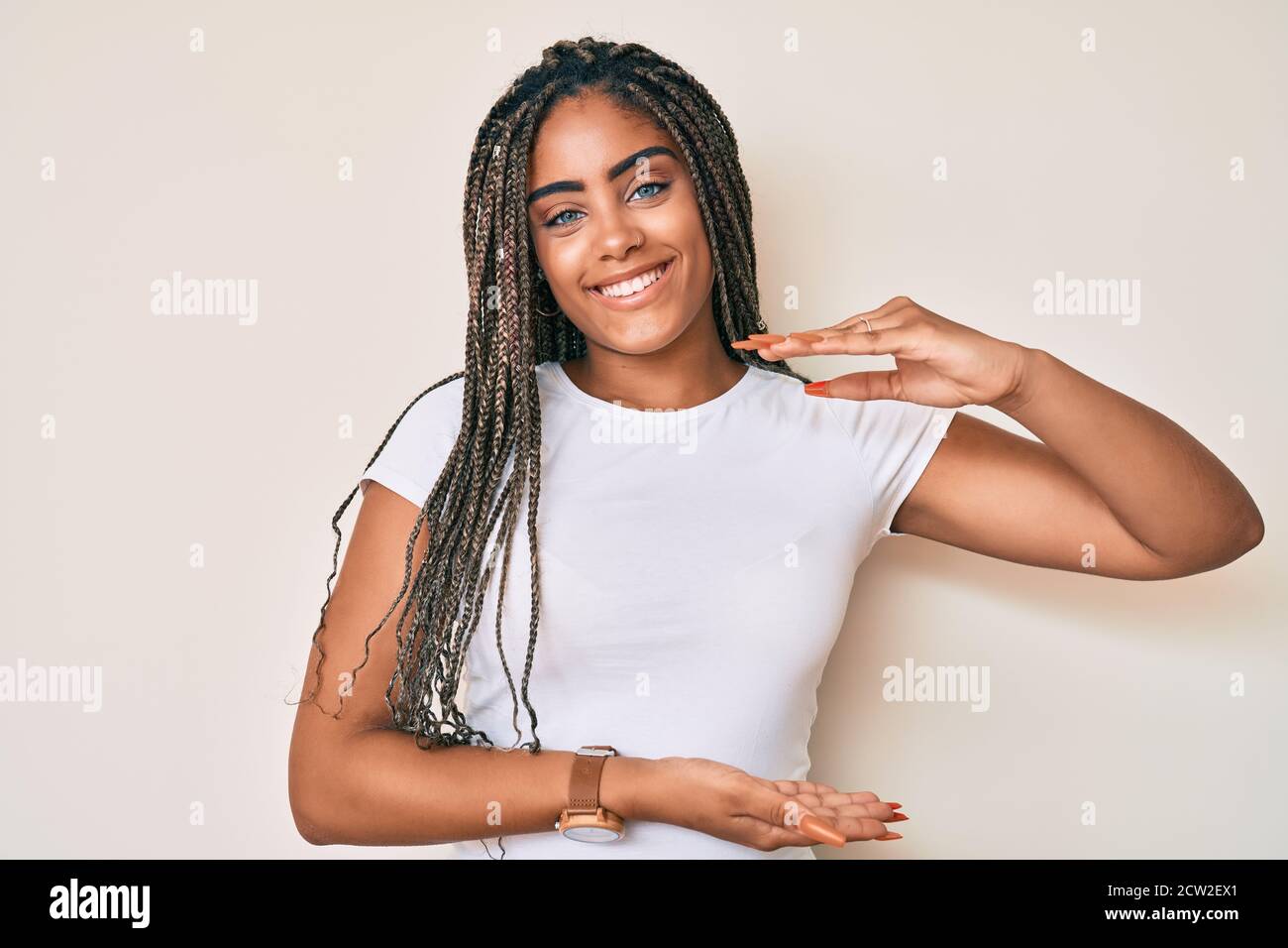 Young african american woman with braids wearing casual white tshirt ...