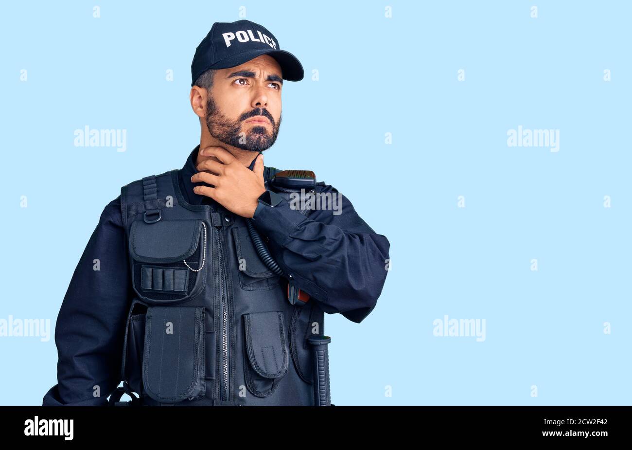 Young hispanic man wearing police uniform touching painful neck, sore ...