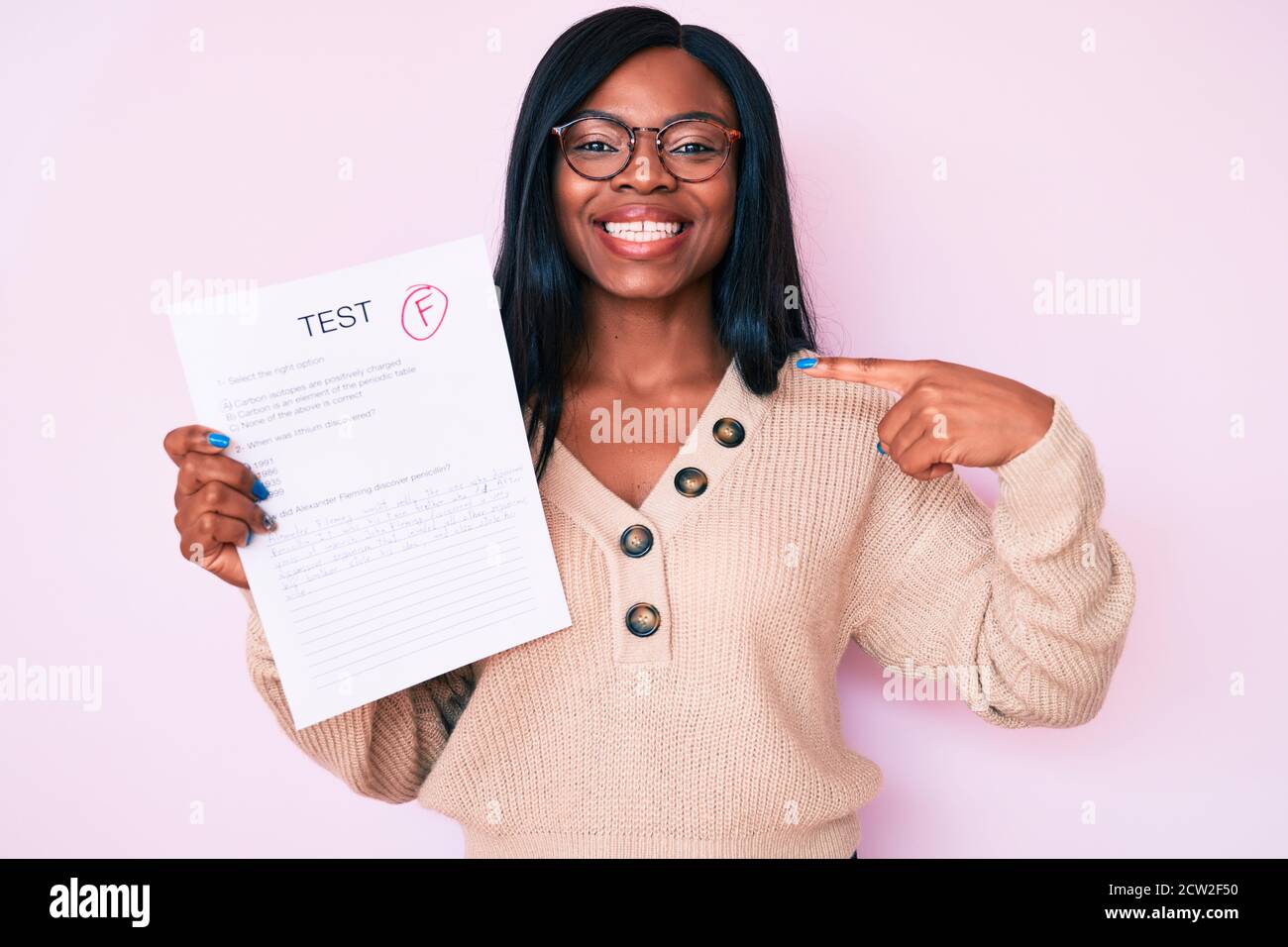 Young african american woman showing a failed exam pointing finger to ...
