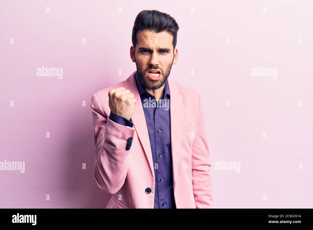Young handsome man with beard wearing elegant jacket angry and mad ...