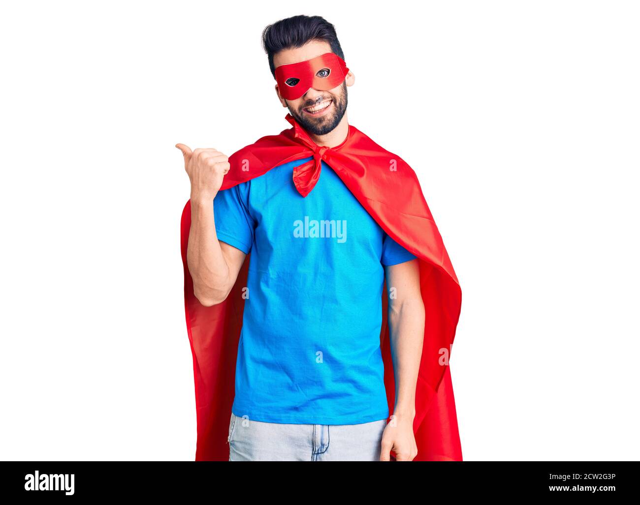 Young handsome man with beard wearing super hero costume smiling with ...