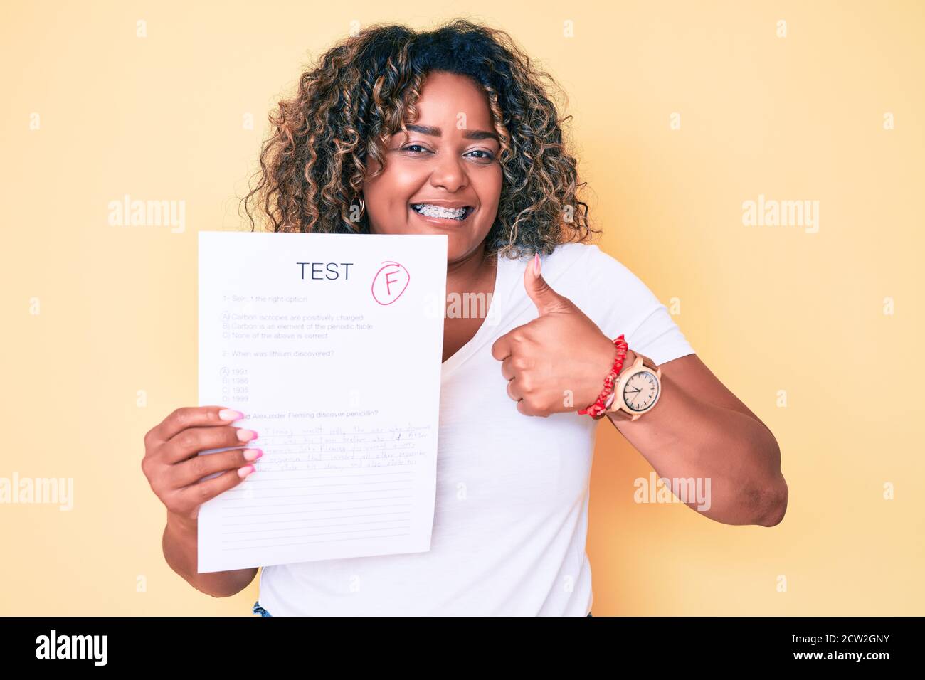 Young african american plus size woman showing a failed exam smiling ...
