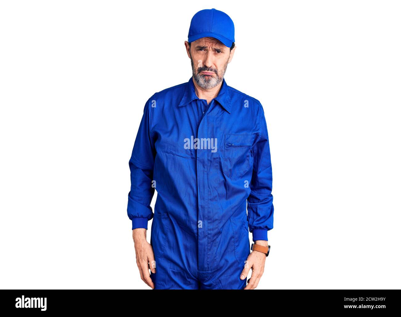 Middle age handsome man wearing mechanic uniform depressed and worry ...