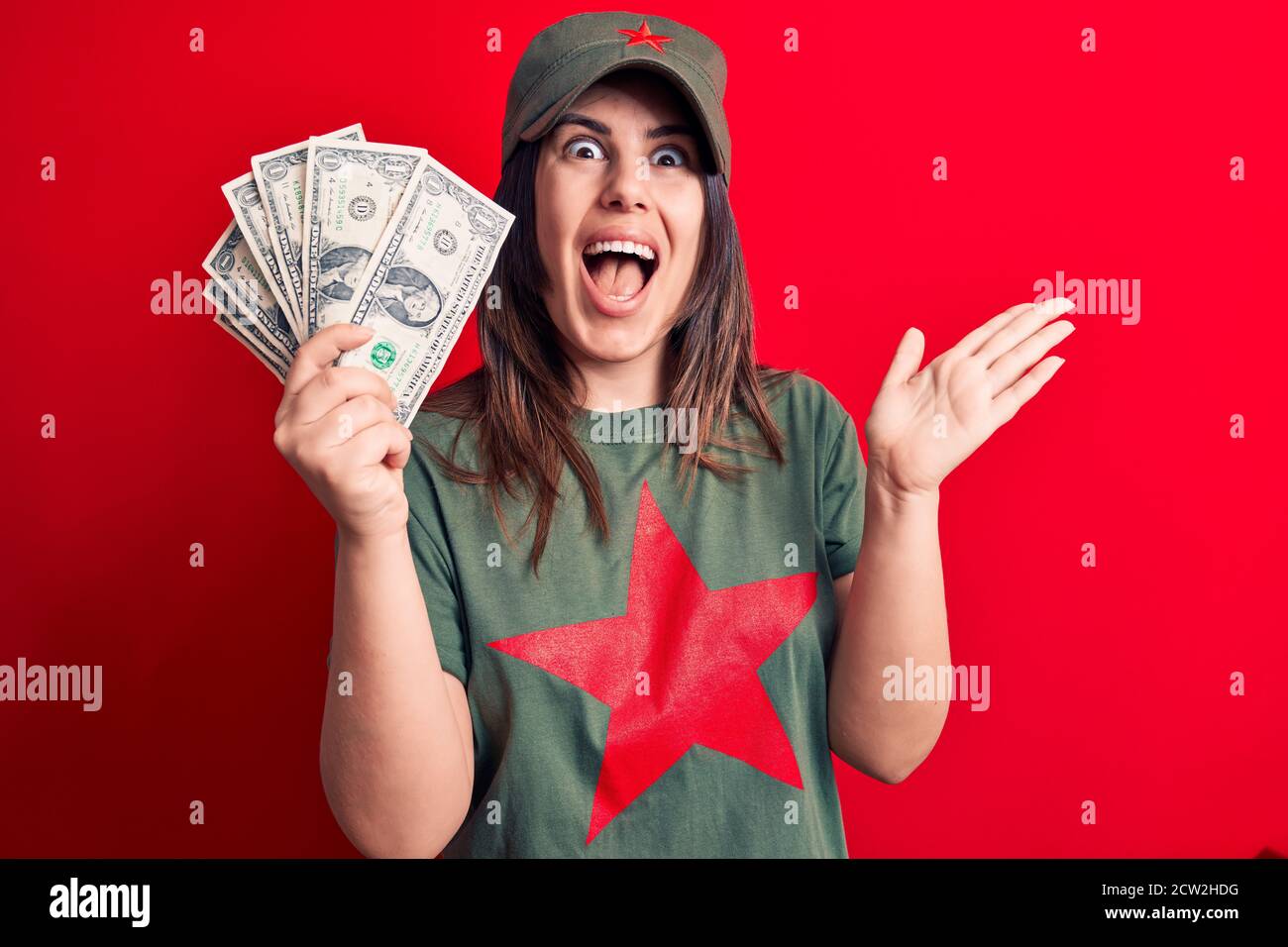 Woman wearing t-shirt with red star communist symbol holding bunch of ...
