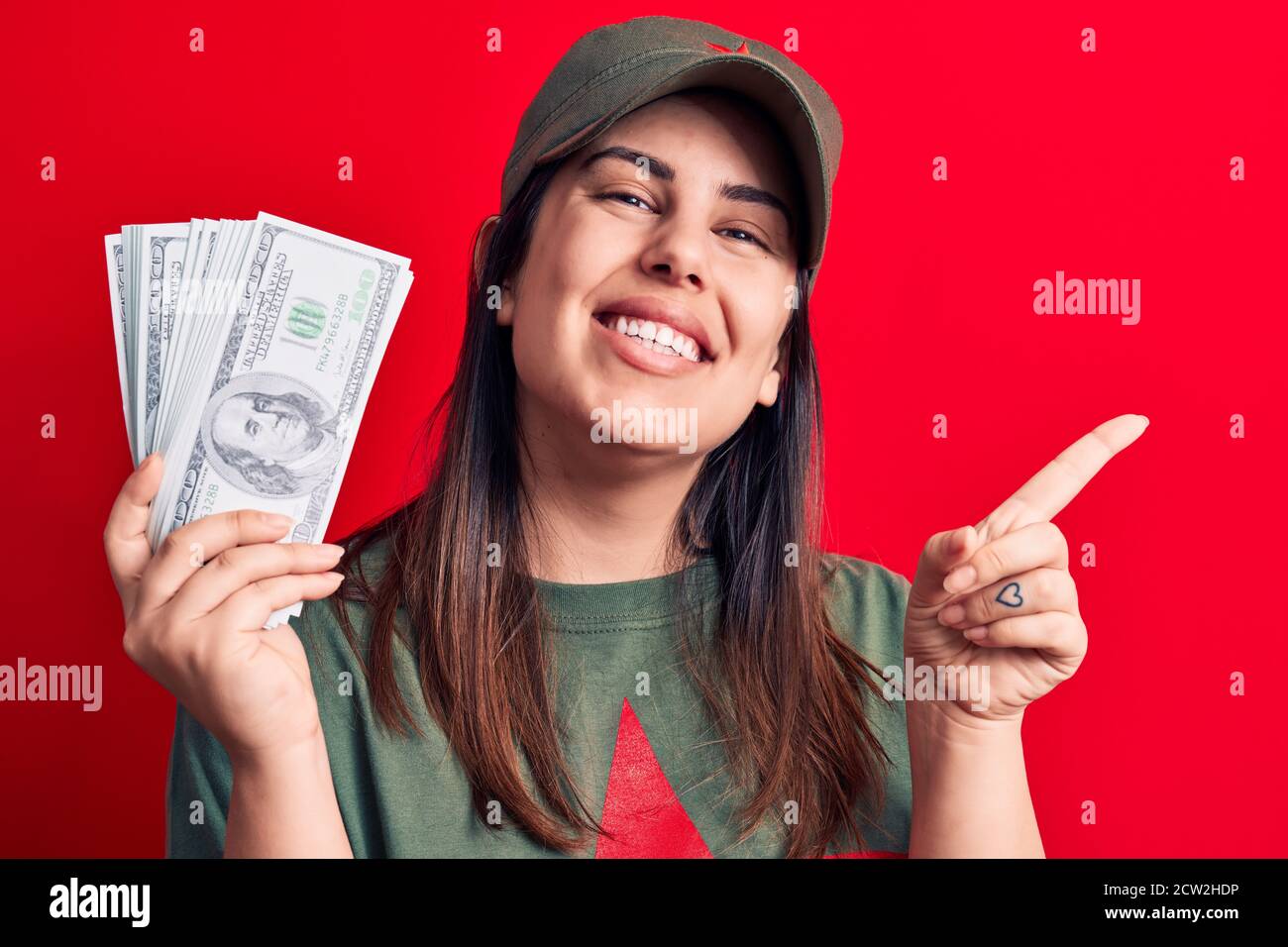 Woman wearing t-shirt with red star communist symbol holding bunch of ...