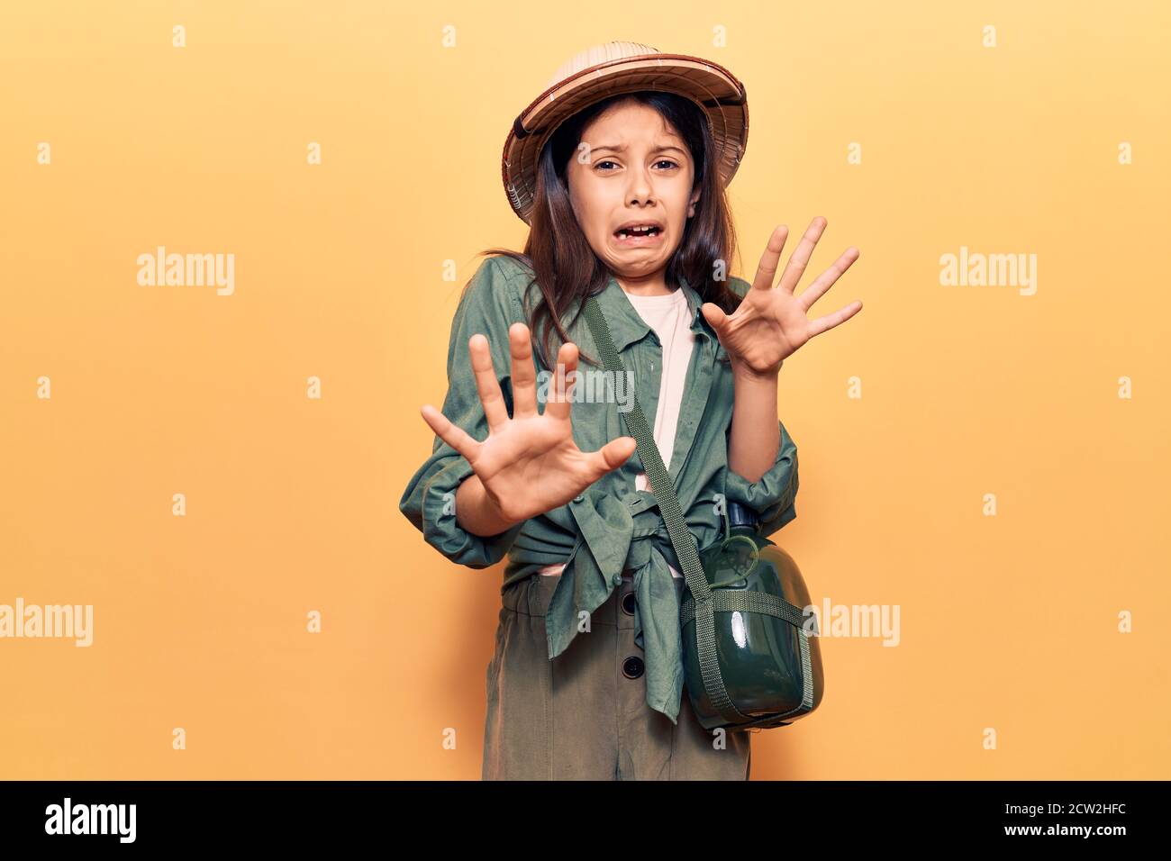 Beautiful child girl wearing explorer hat afraid and terrified with ...