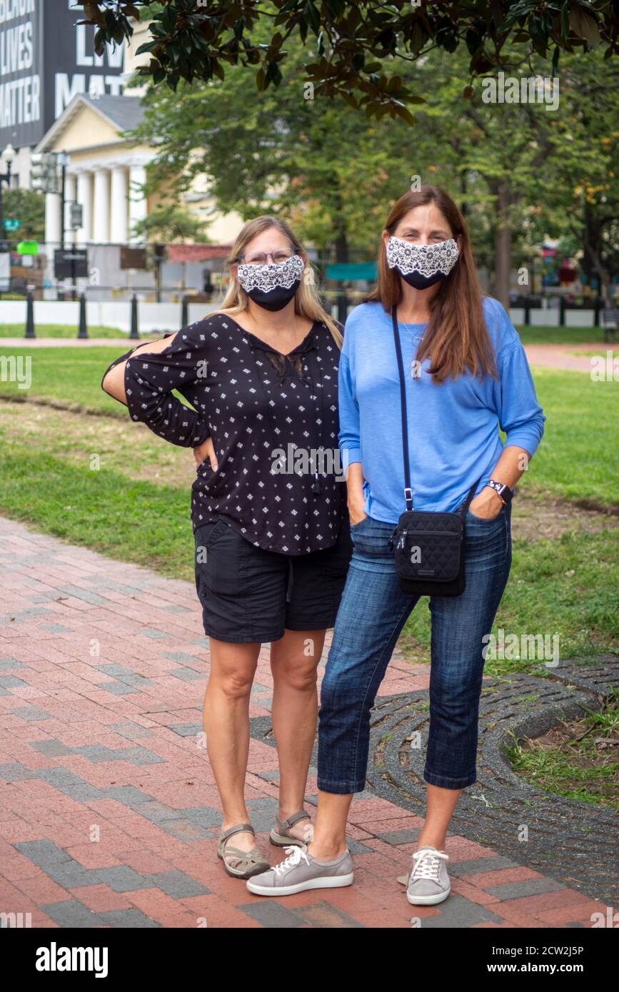 Two women mourners in black face masks with RBG lace trim Stock Photo ...