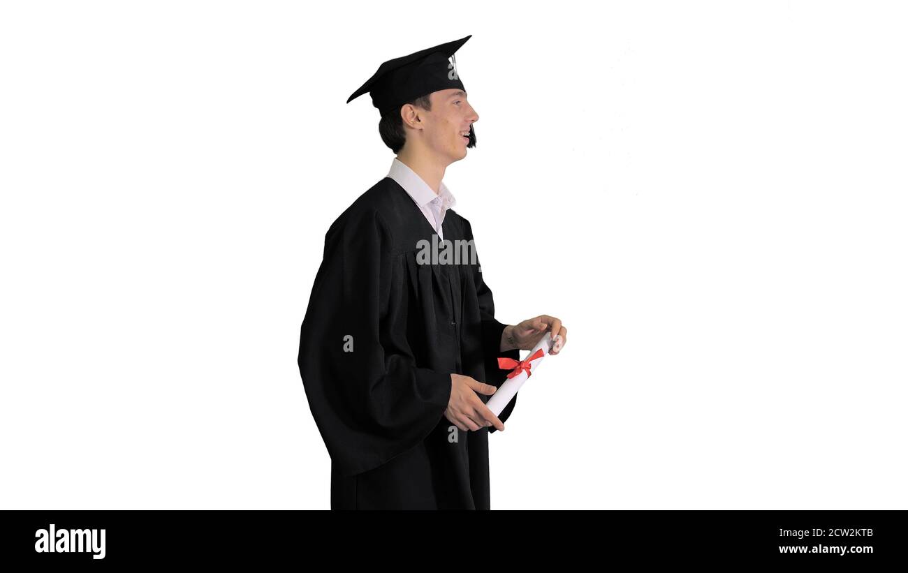 Graduate student walking and smiling on white background Stock Photo ...