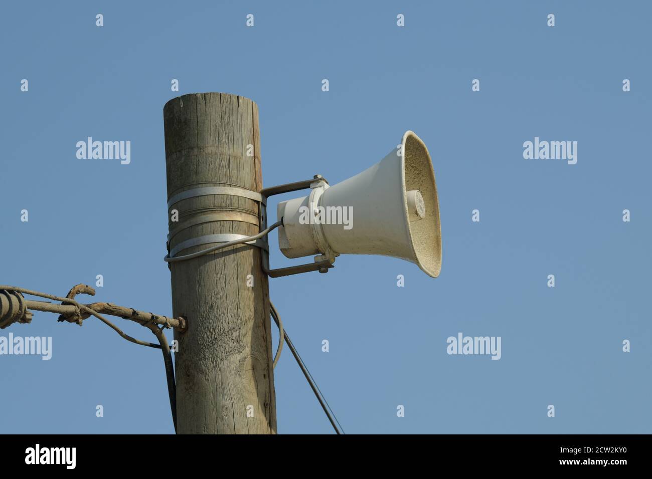 Outdoor loudspeaker on wooden pole, communication device, abstract ...