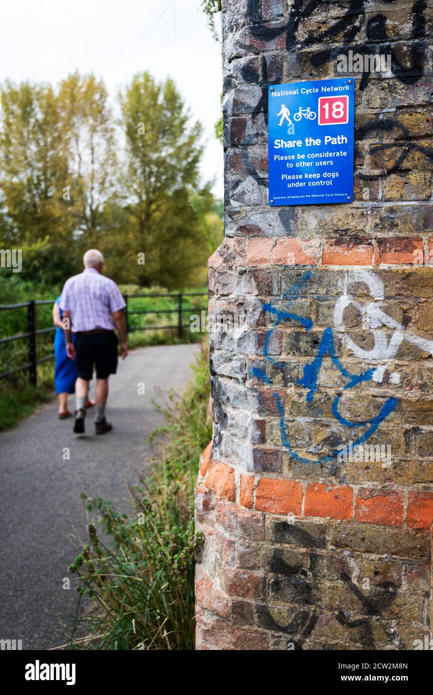 Guidance sign on wall beside path asking cyclists and walkers to 'Share ...