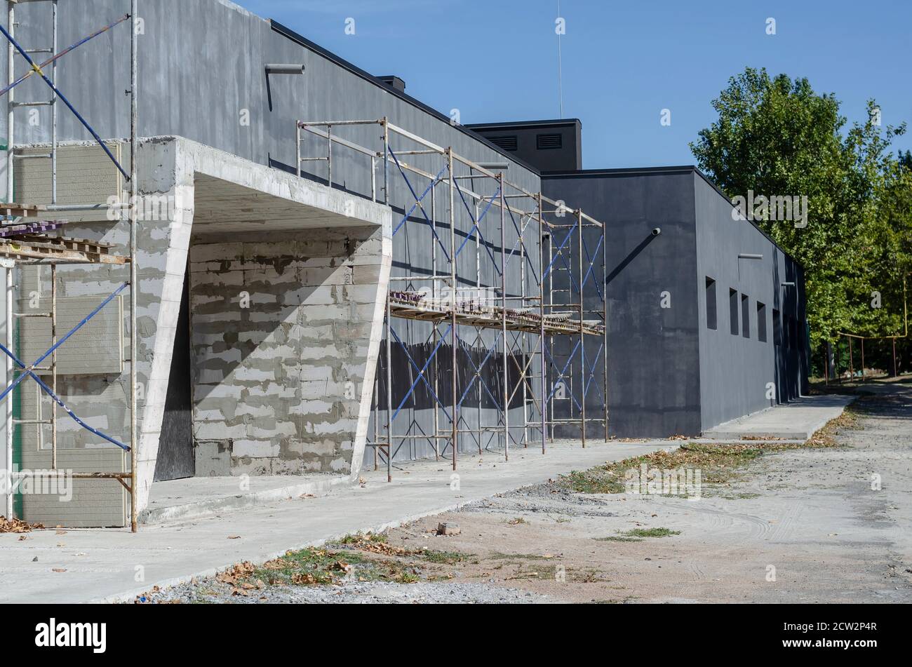 Scaffolding near a gray one-story building. Repair and reconstruction ...