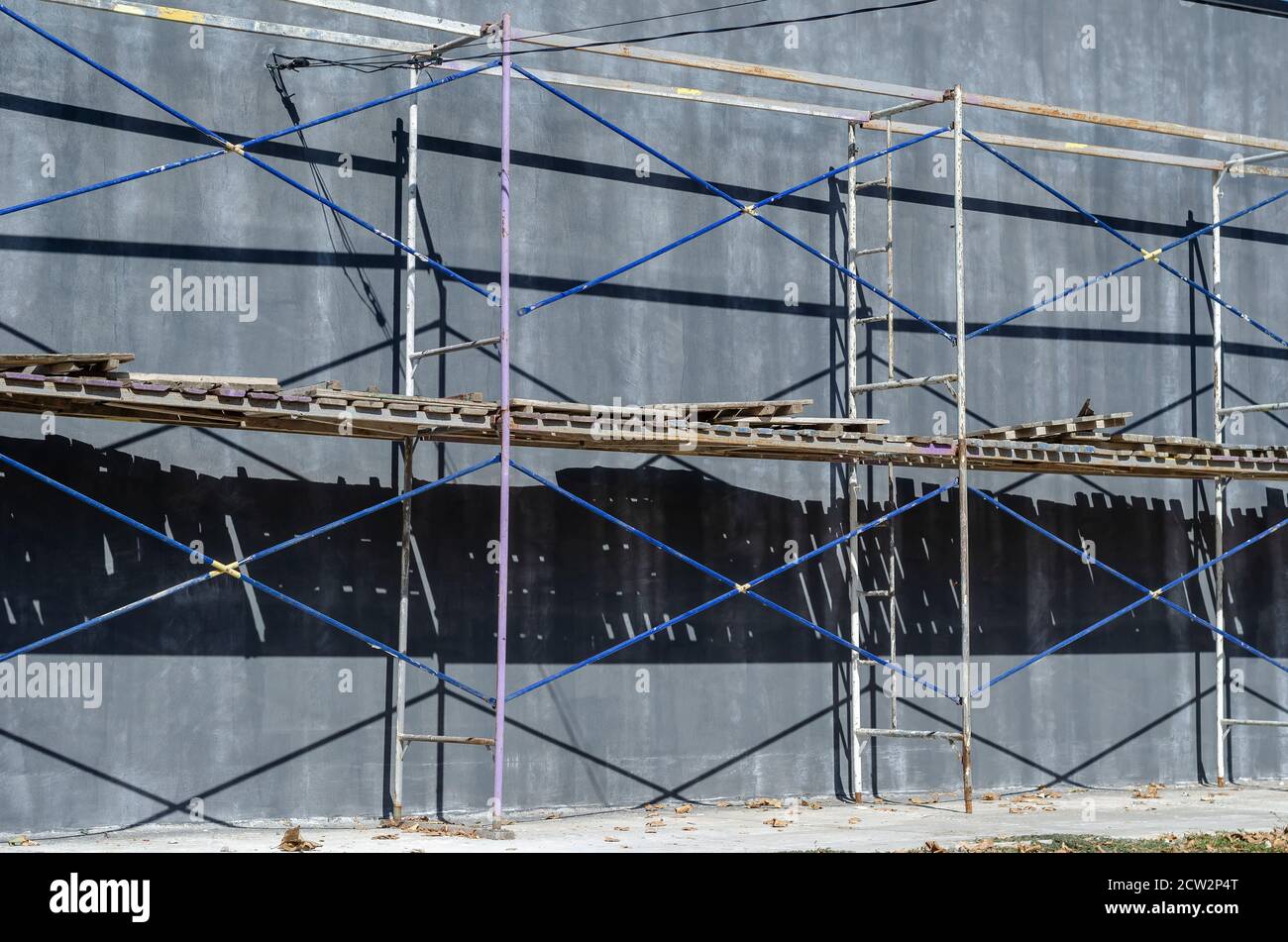 Scaffolding near a gray one-story building. Repair and reconstruction ...