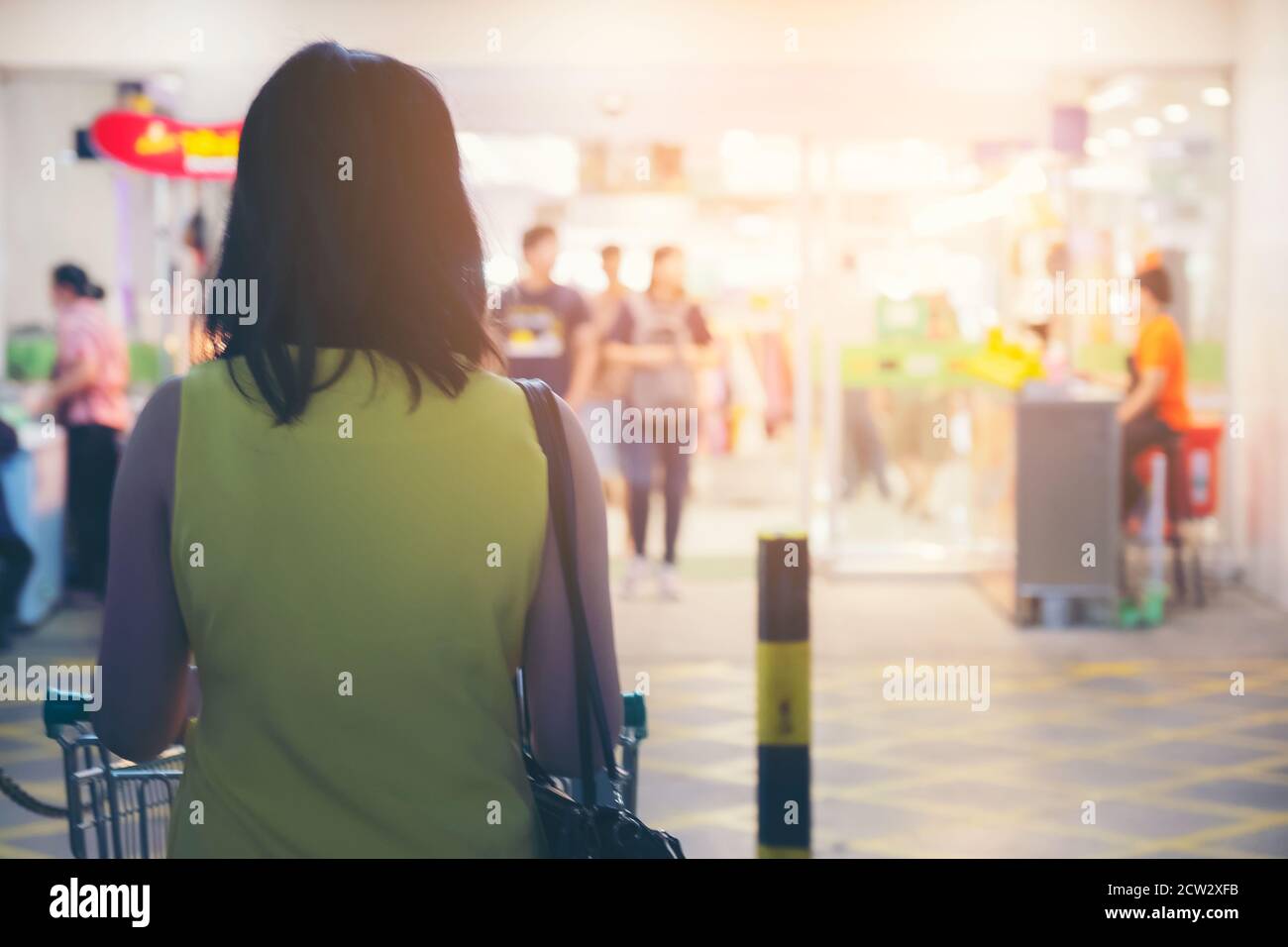 Back side of Woman shopping in Supermarket Aisle and Shelves product in ...