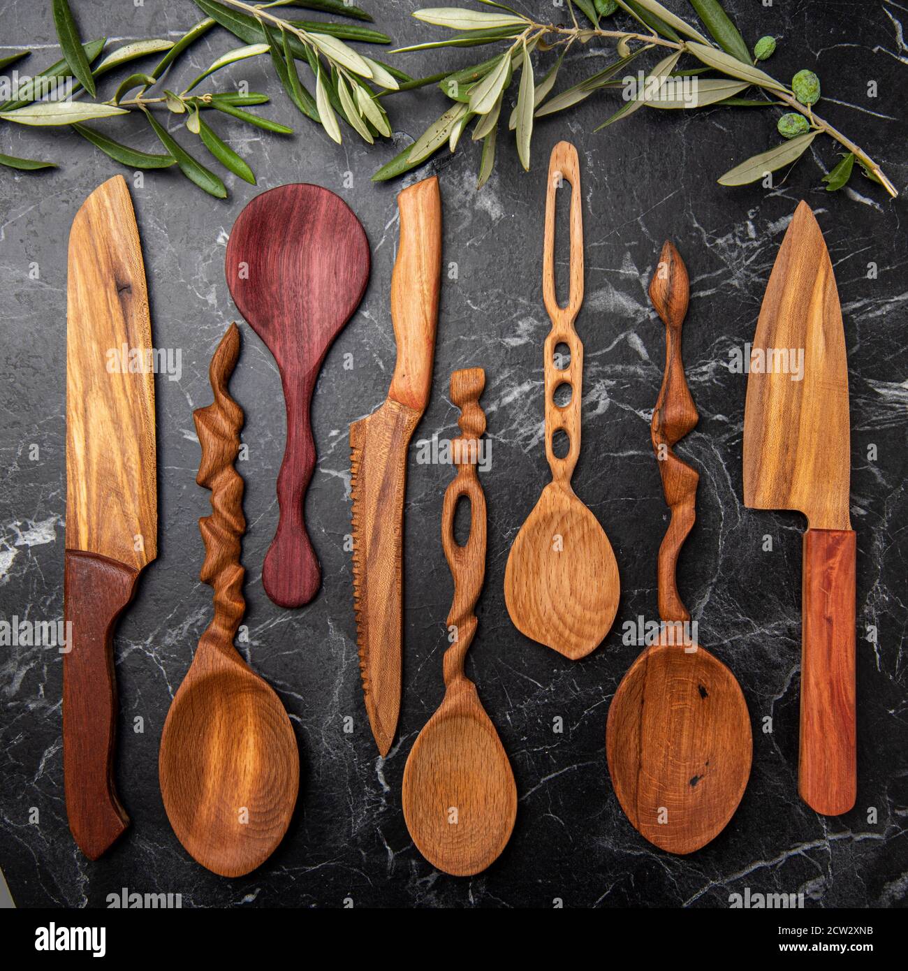 handmade wooden spoons and knives on black marble Stock Photo - Alamy