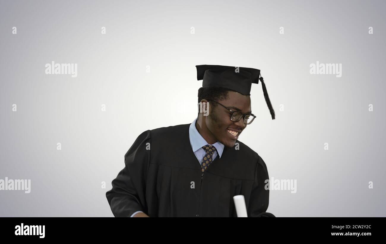 Excited african american male student in graduation robe dancing Stock ...