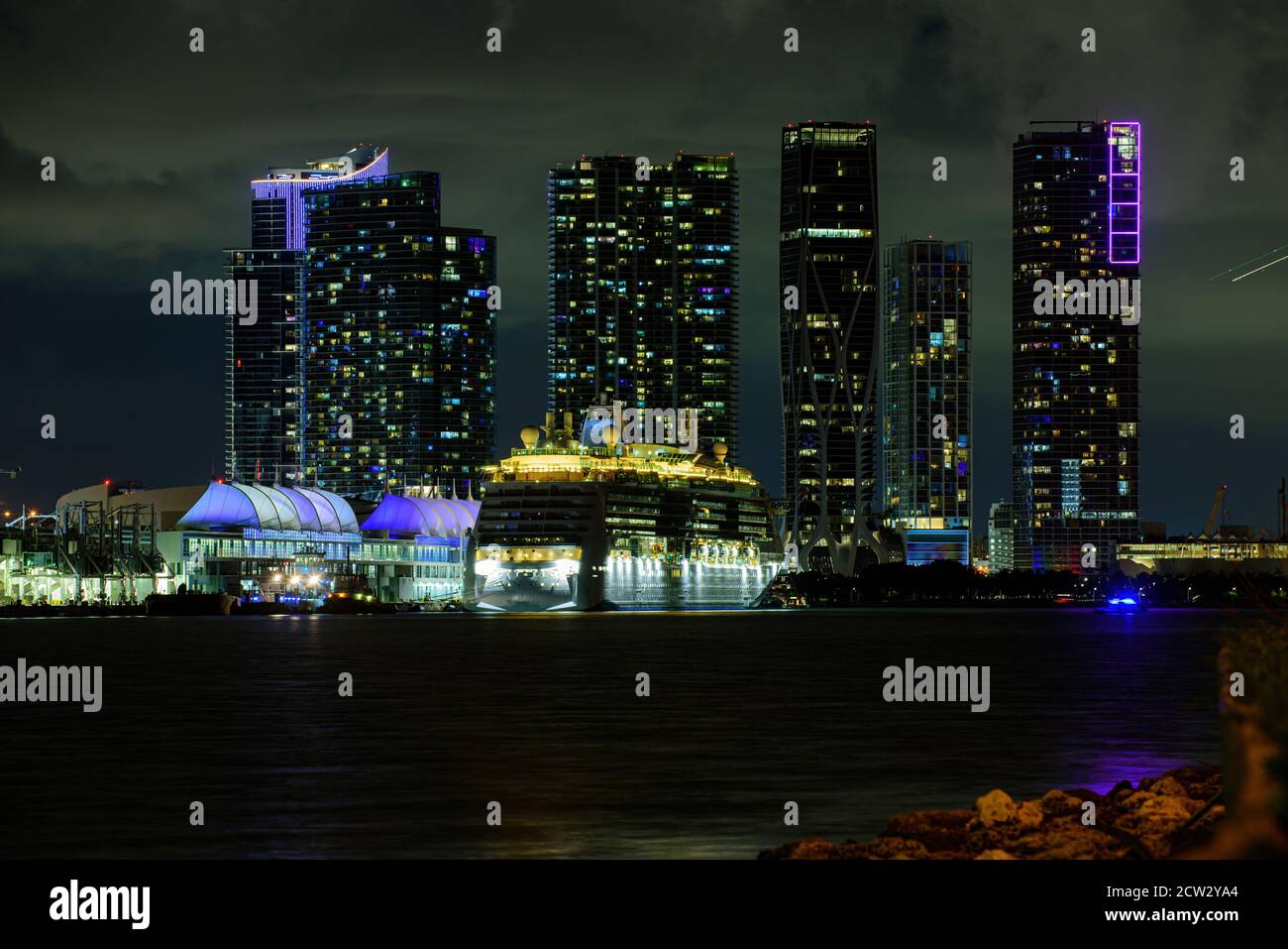 Cruise ship in the Port of Miami at sunset with multiple luxury yachts ...