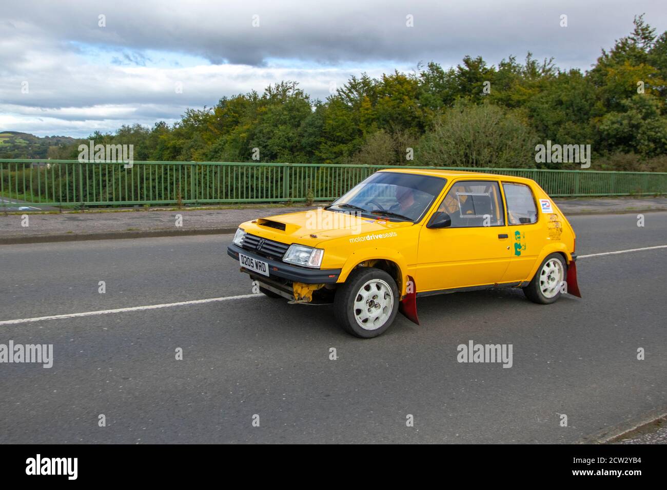 1987 80s yellow Peugeot 205 GTI; Vehicular traffic, moving vehicles ...