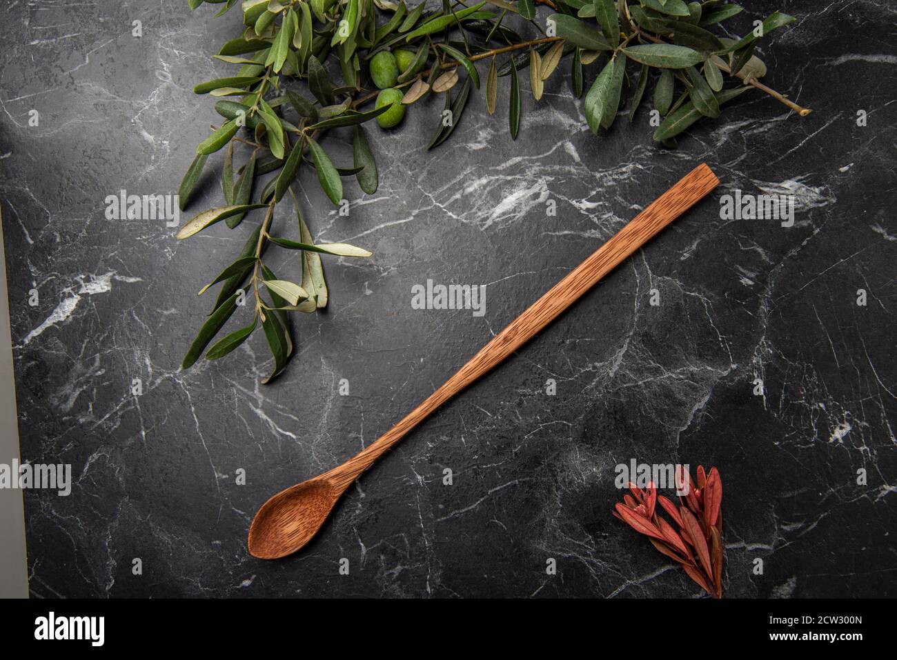 handmade wooden spoons on black marble Stock Photo - Alamy