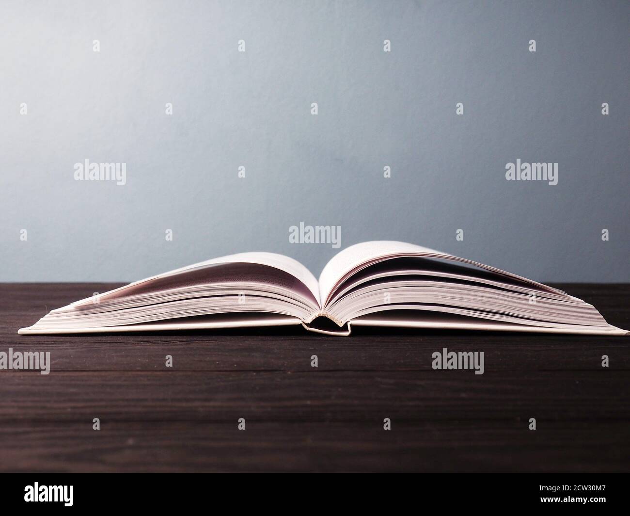 Open book on blue background, open pages as a concept of new knowledge ...