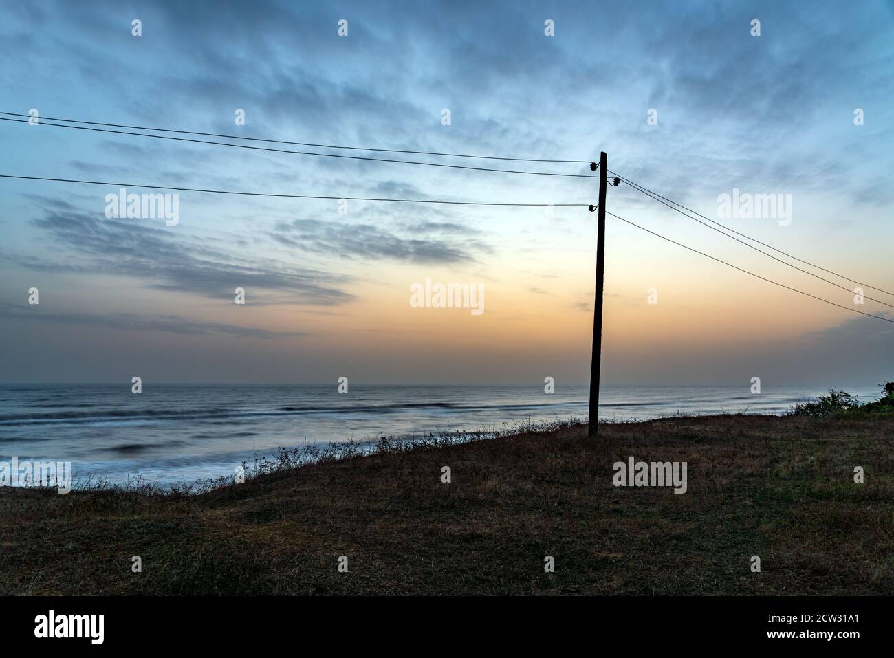 Power line pillar along the sea Stock Photo - Alamy