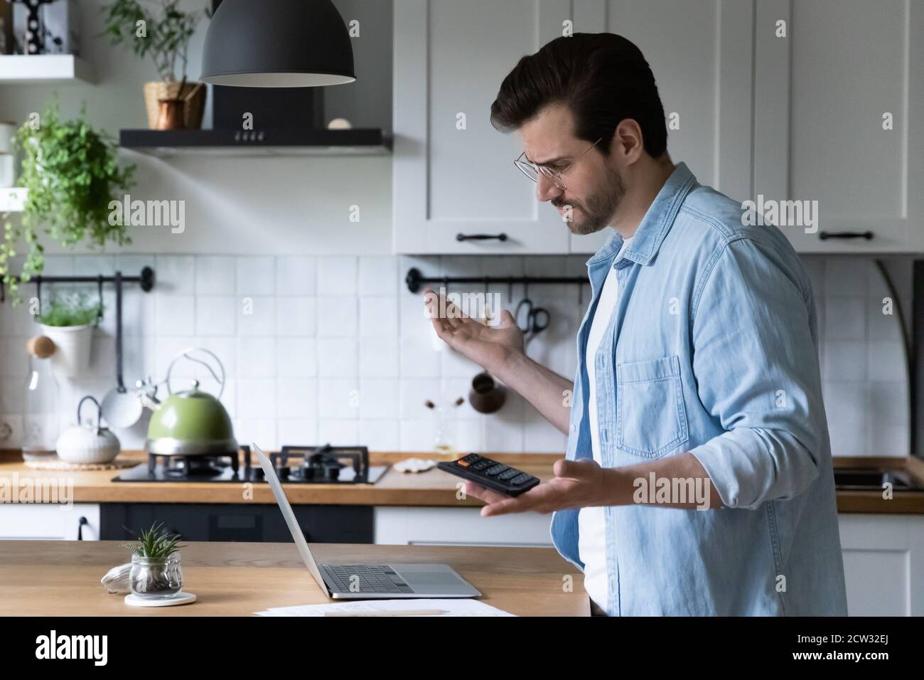 Frustrated man confused by financial error making payment Stock Photo ...