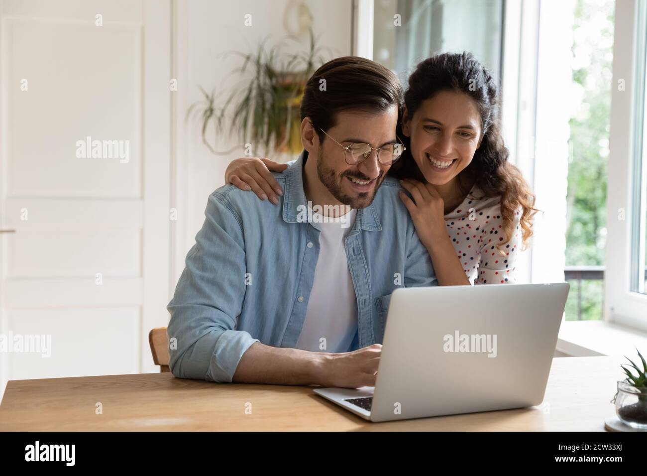 Happy couple use modern laptop at home together Stock Photo - Alamy