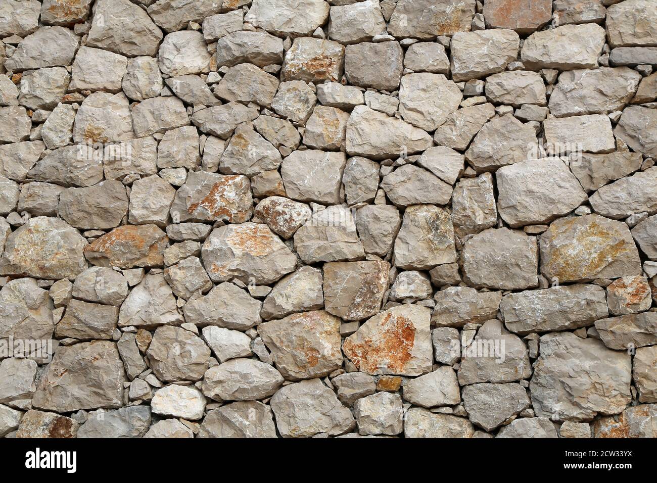 Gray stone wall made of natural stone Stock Photo - Alamy