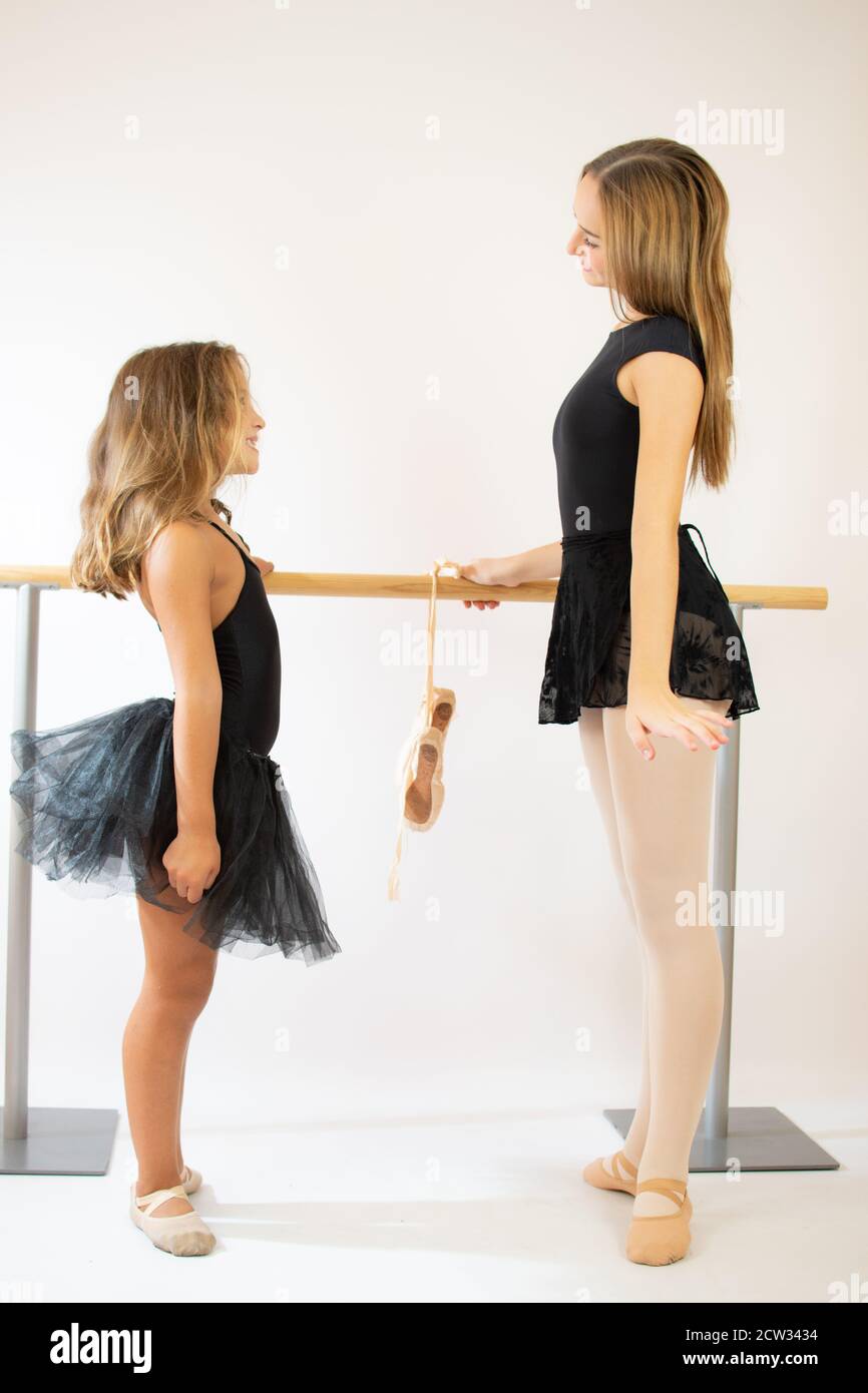Teacher of the ballet school helps young ballerina perform different ...