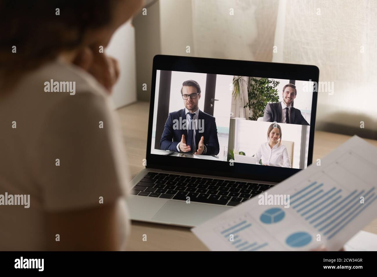 Female employee talk on video call with diverse coworkers Stock Photo ...