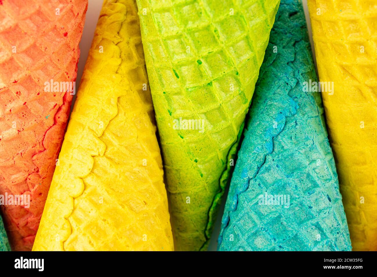 Set of various bright multicolored ice-cream waffle cones on white ...